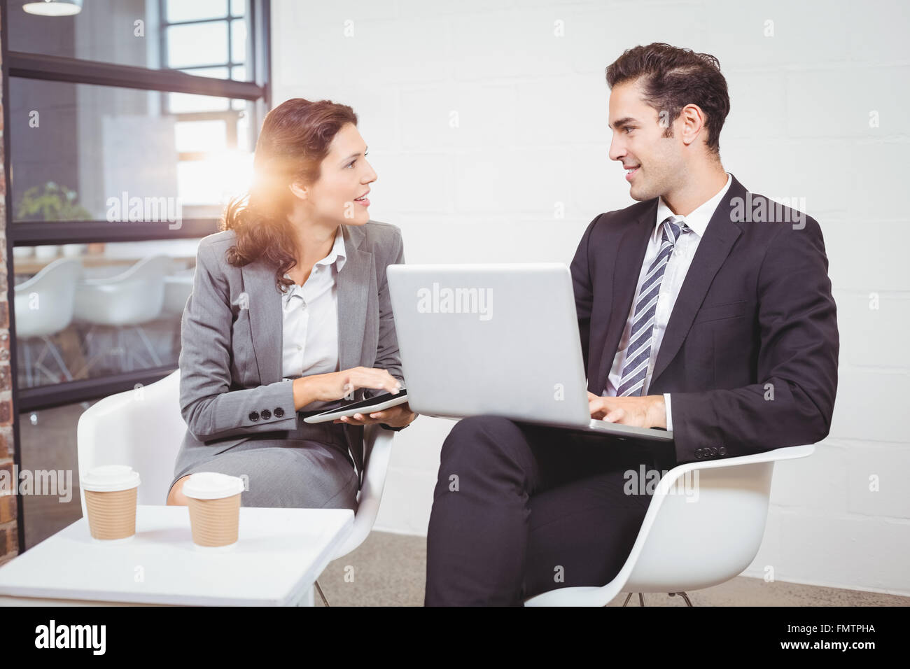 Happy business people using technology Stock Photo - Alamy