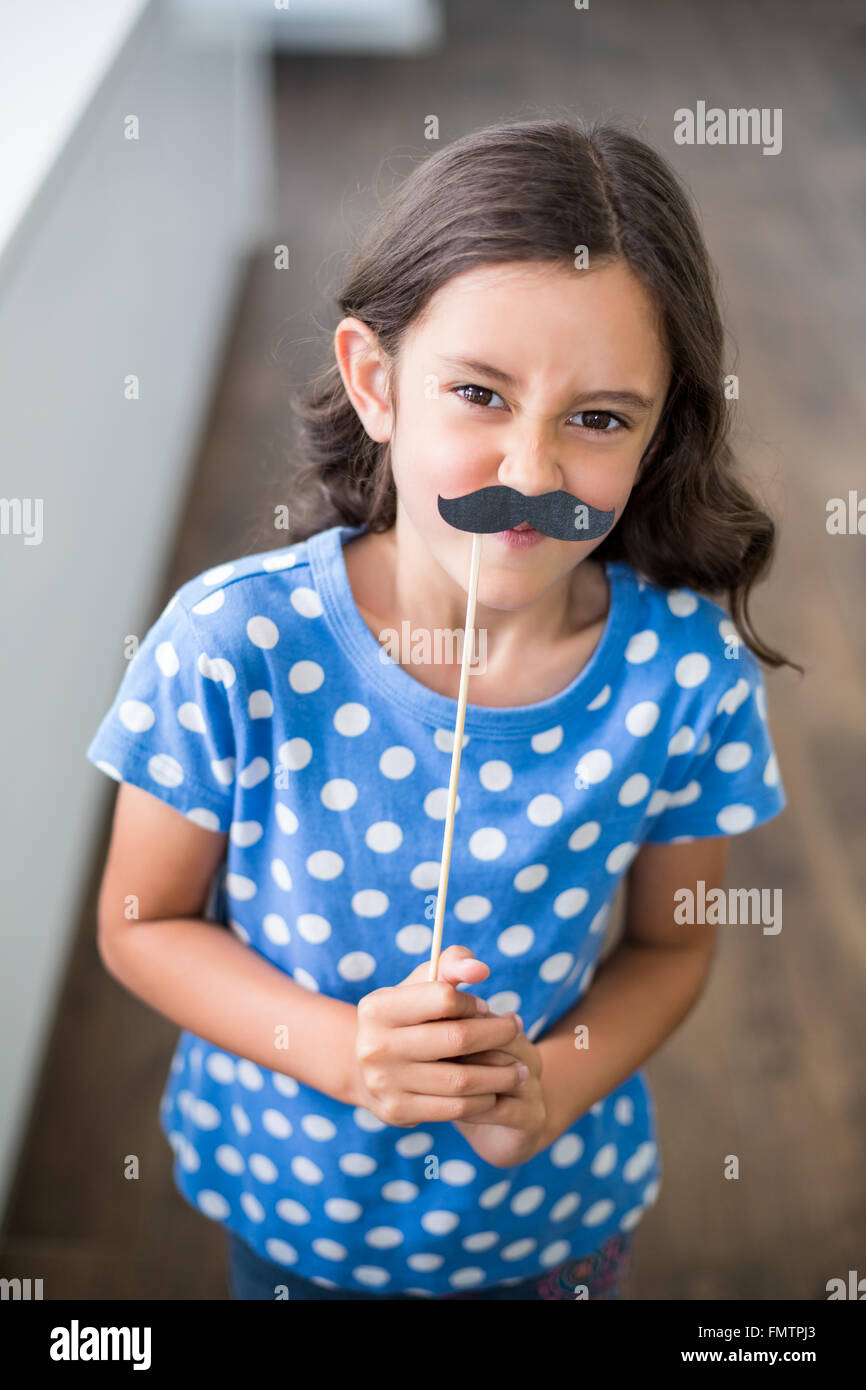 Portrait of girl with artificial mustache Stock Photo - Alamy