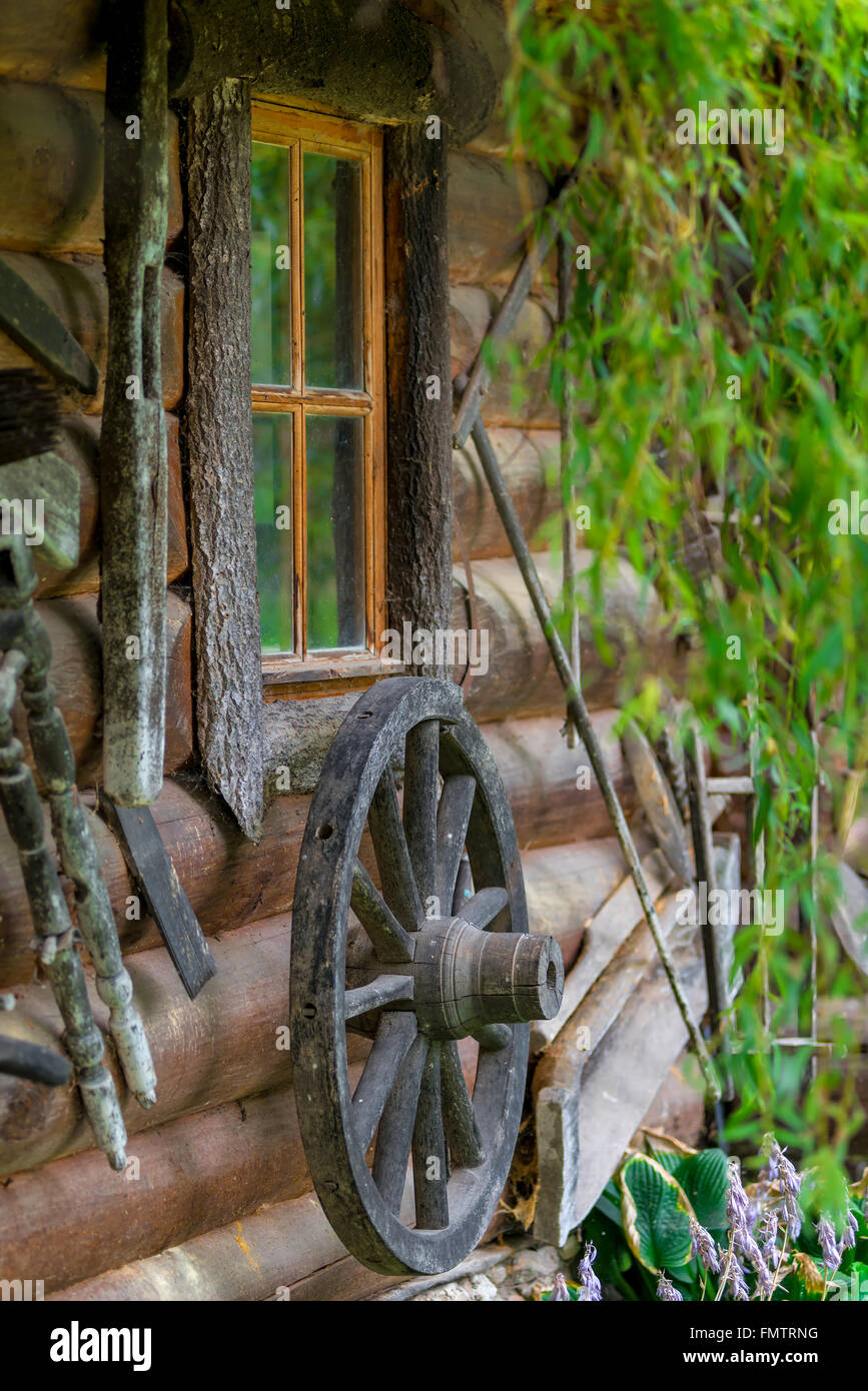 wheel from an old cart near wooden rural house Stock Photo - Alamy