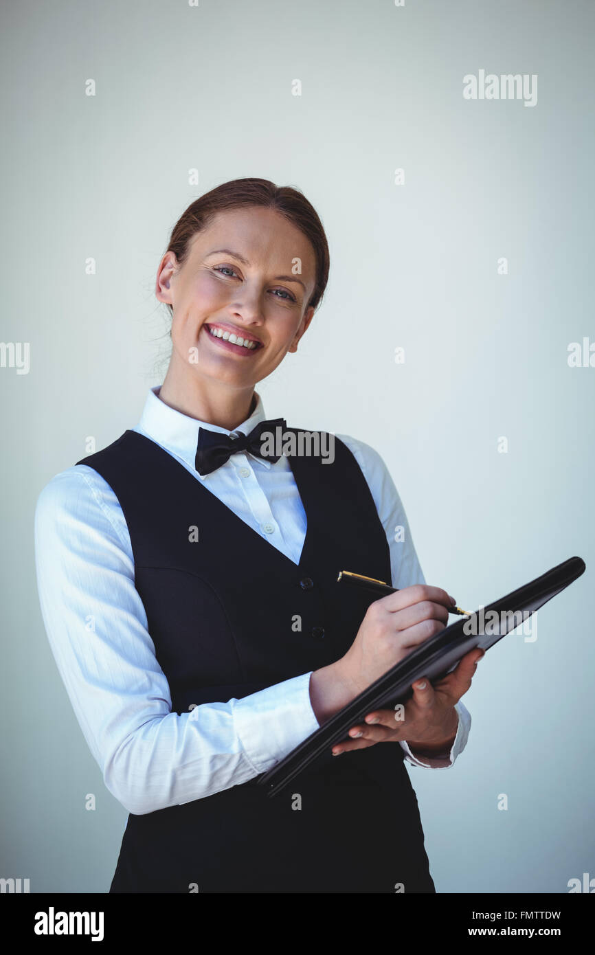 Smiling waitress taking an order Stock Photo - Alamy