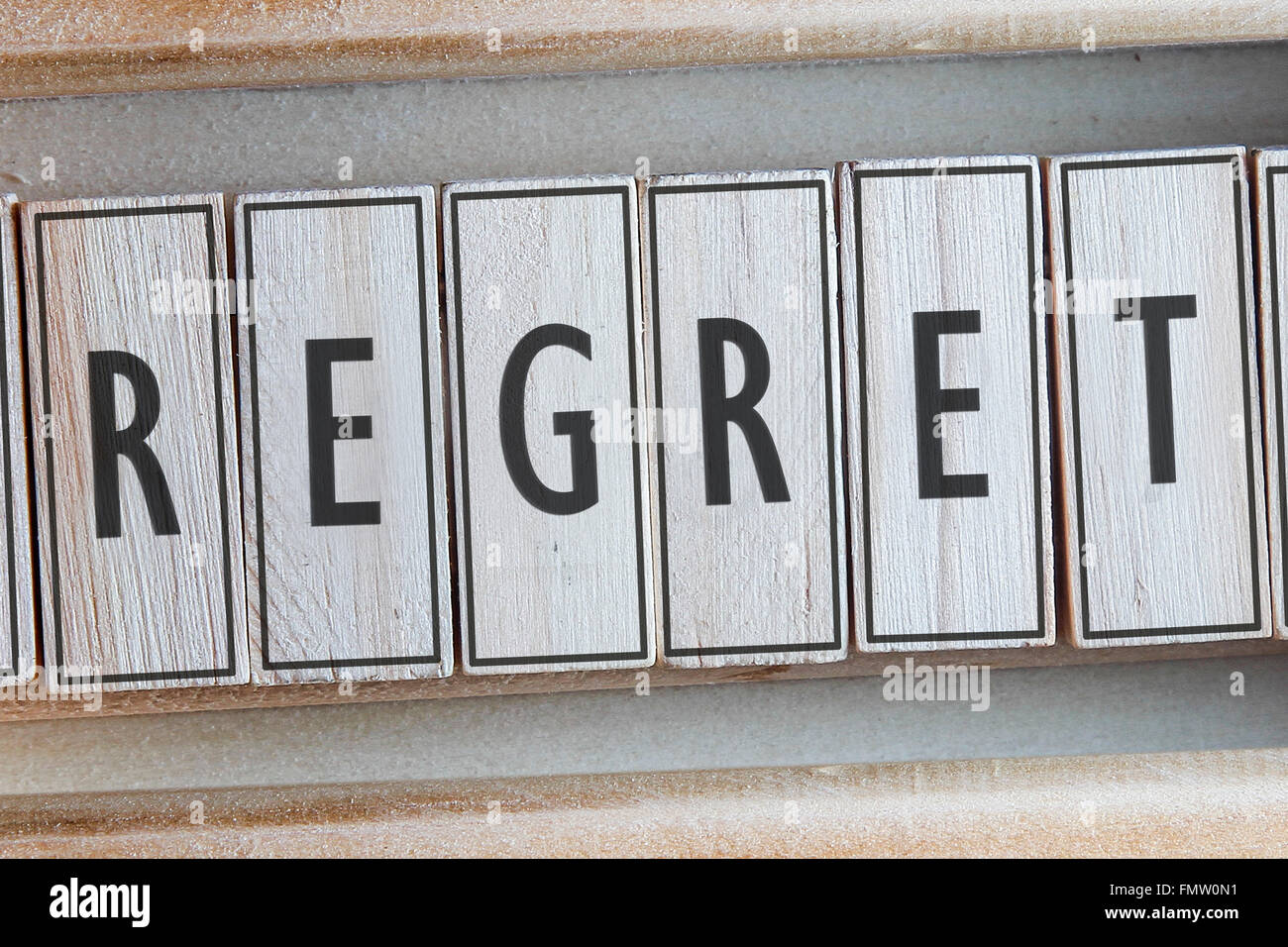Regret word written on wood Stock Photo - Alamy