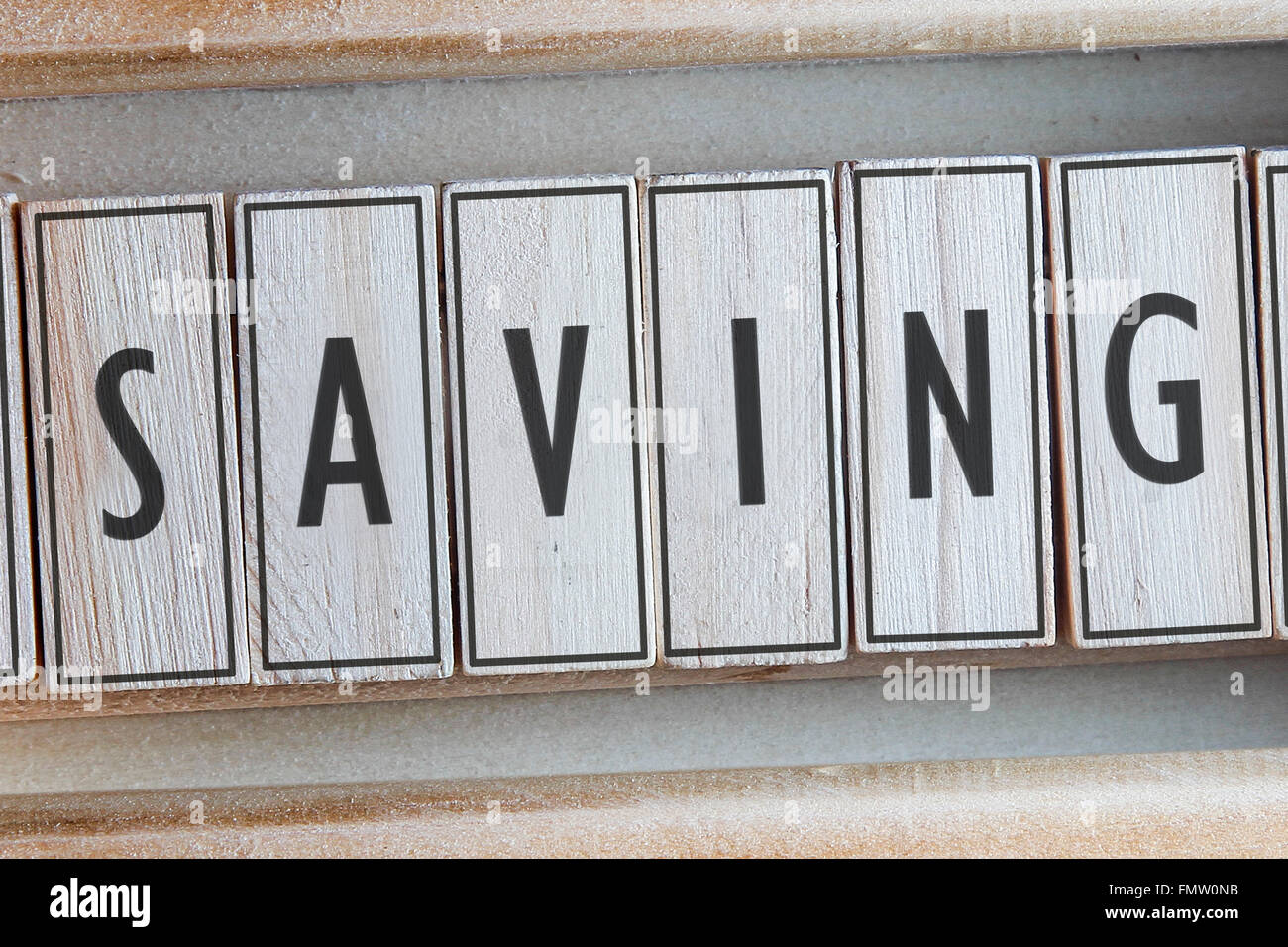 Saving word written on wood Stock Photo - Alamy