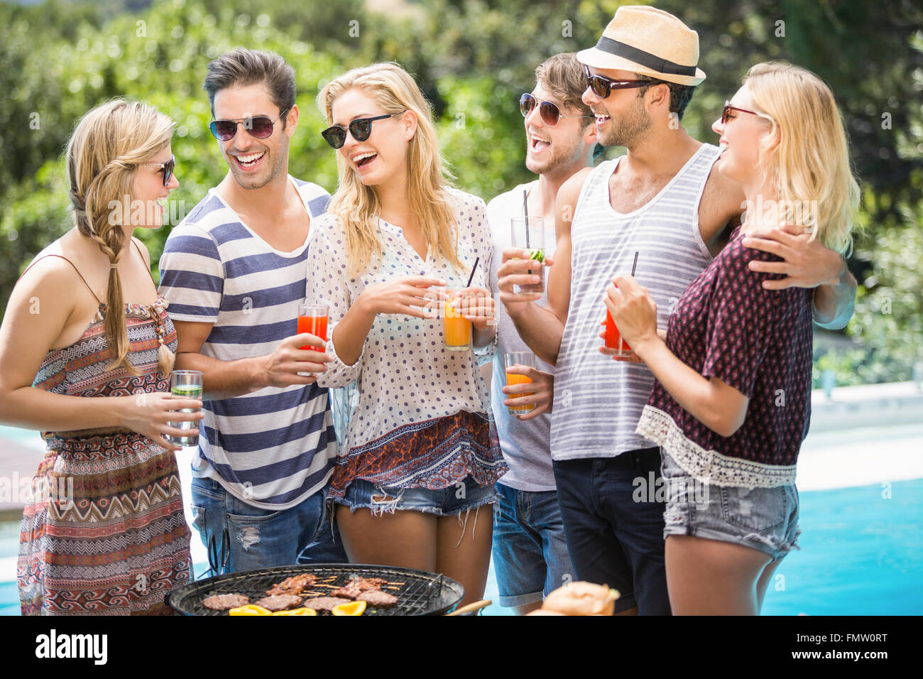 Group of happy friends having juice Stock Photo - Alamy