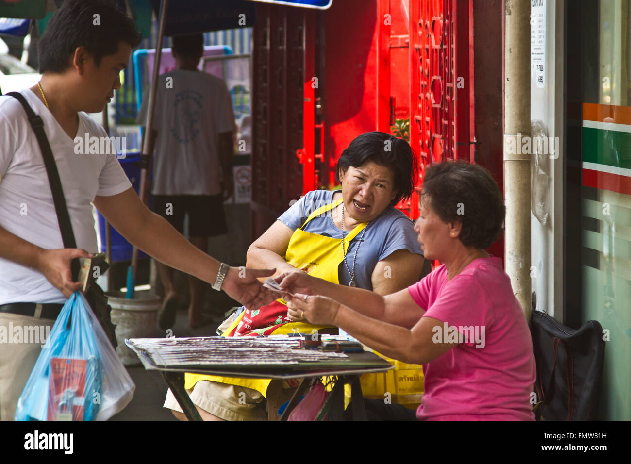Woman working in the street of Bangkok Stock Photo - Alamy