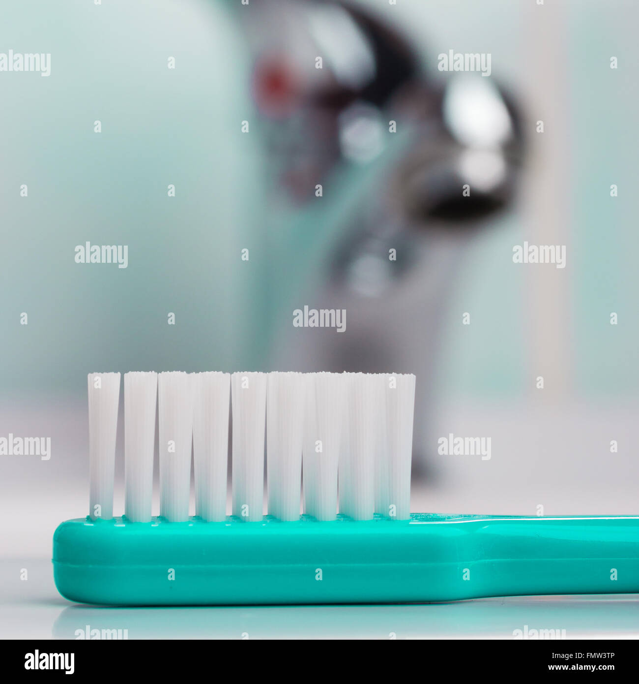 Dental care health concept. Closeup green brush toothbrush in bathroom ...