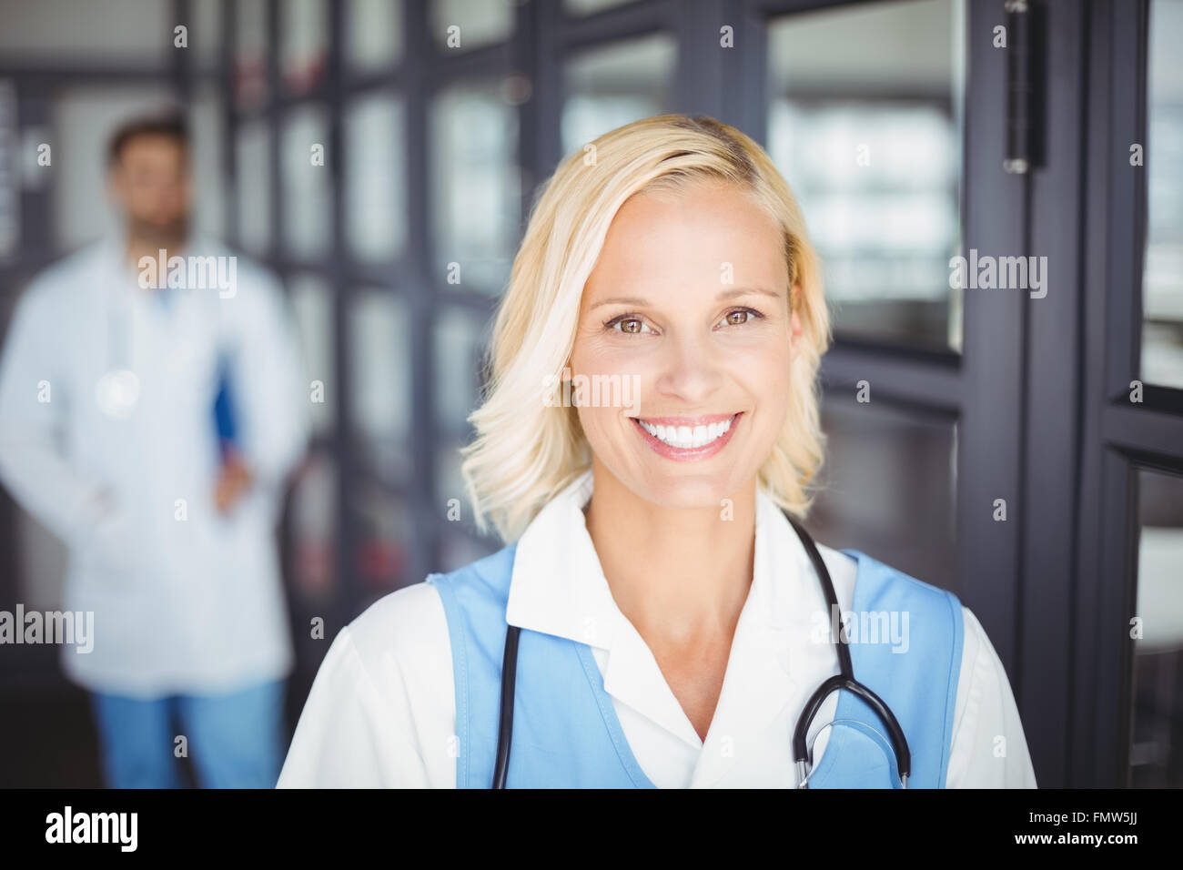 Cheerful young female doctor hi-res stock photography and images - Alamy