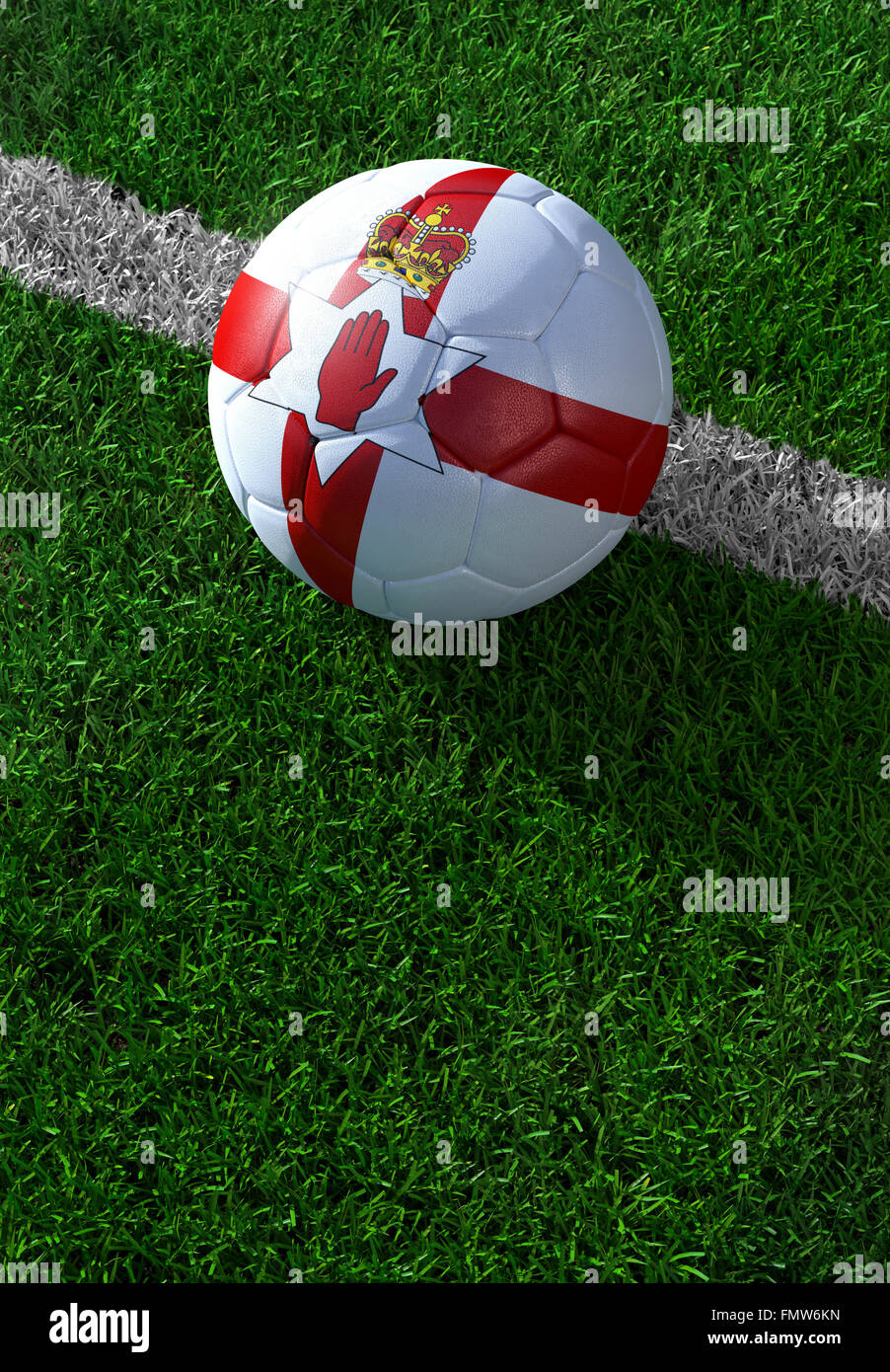 Soccer ball and national flag of Northern Ireland lies on the green ...