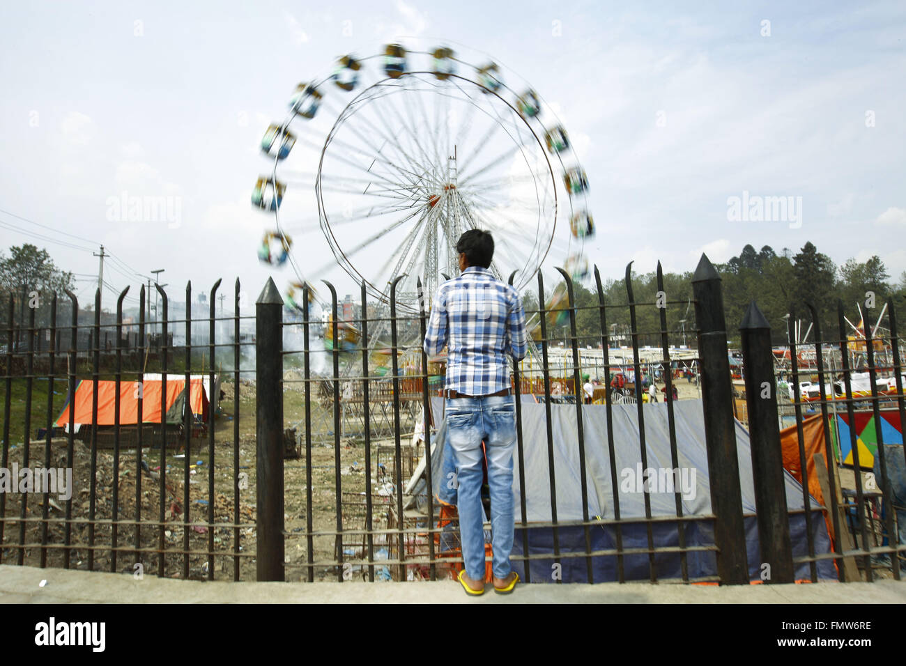 Kathmandu, Nepal. 13th Mar, 2016. A person watches as a Ferris wheel ...