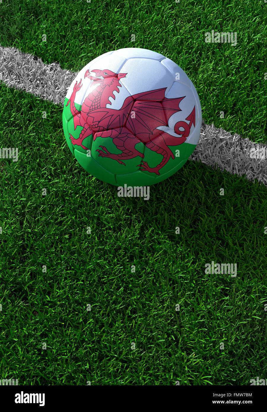 Soccer ball and national flag of Wales lies on the green grass Stock ...
