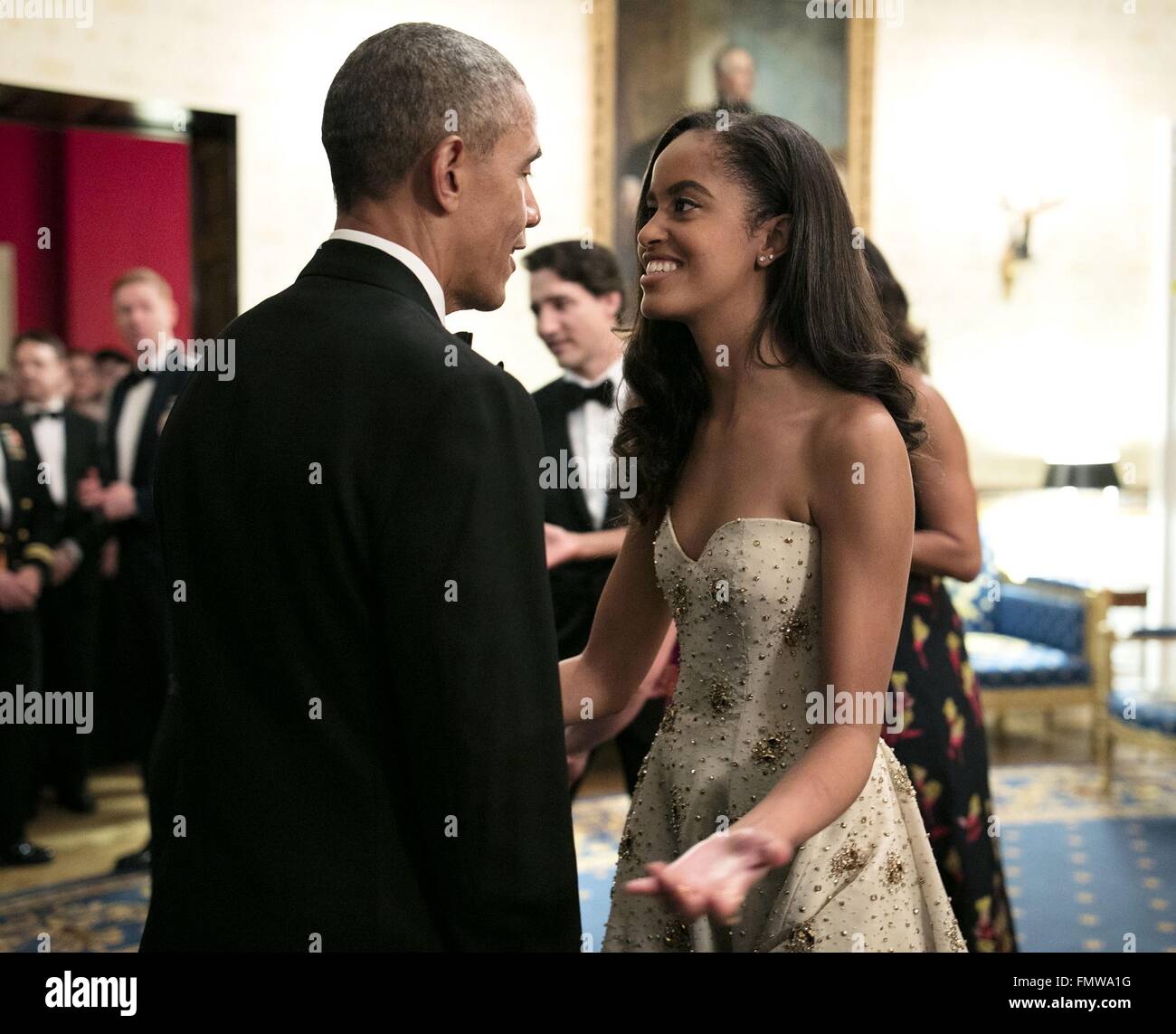 U.S. President Barack Obama speaks with daughter Malia during a ...