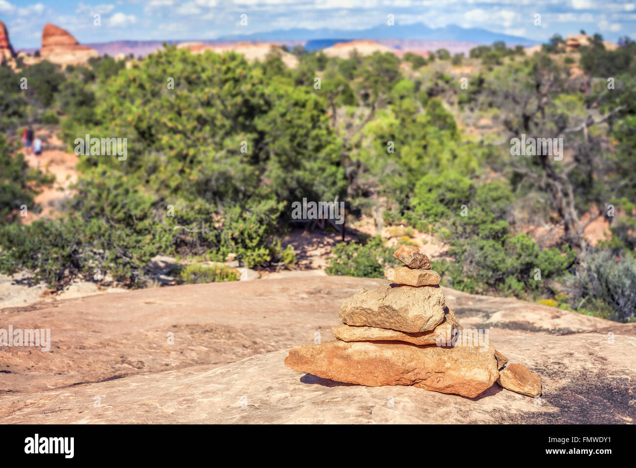 Trail marker made of stones by trekking path, shallow depth of field ...
