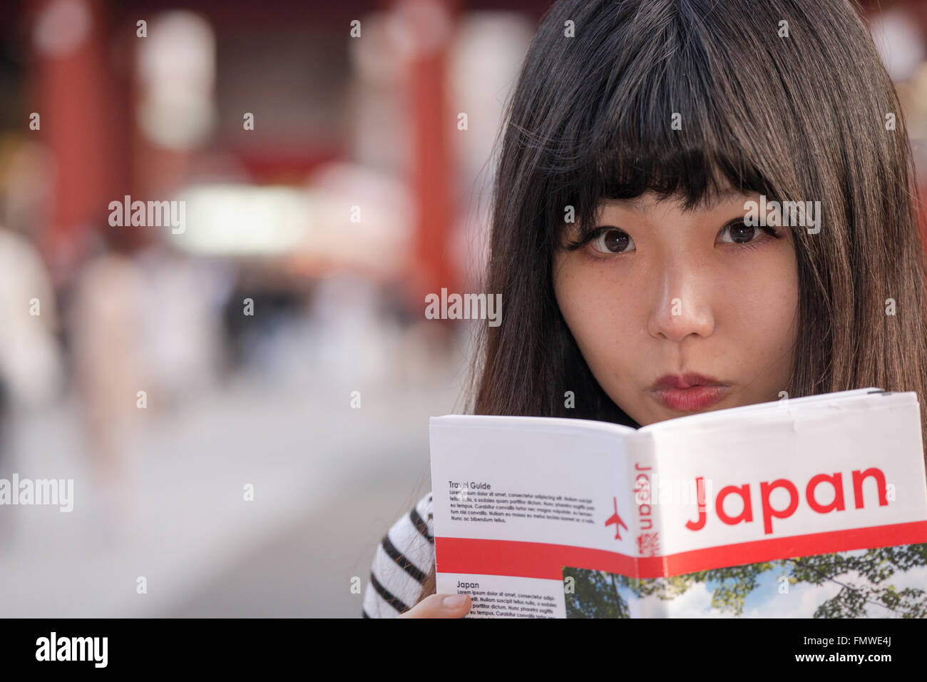 A young Japanese lady at Tokyo's premiere tourist attraction Sensoji ...