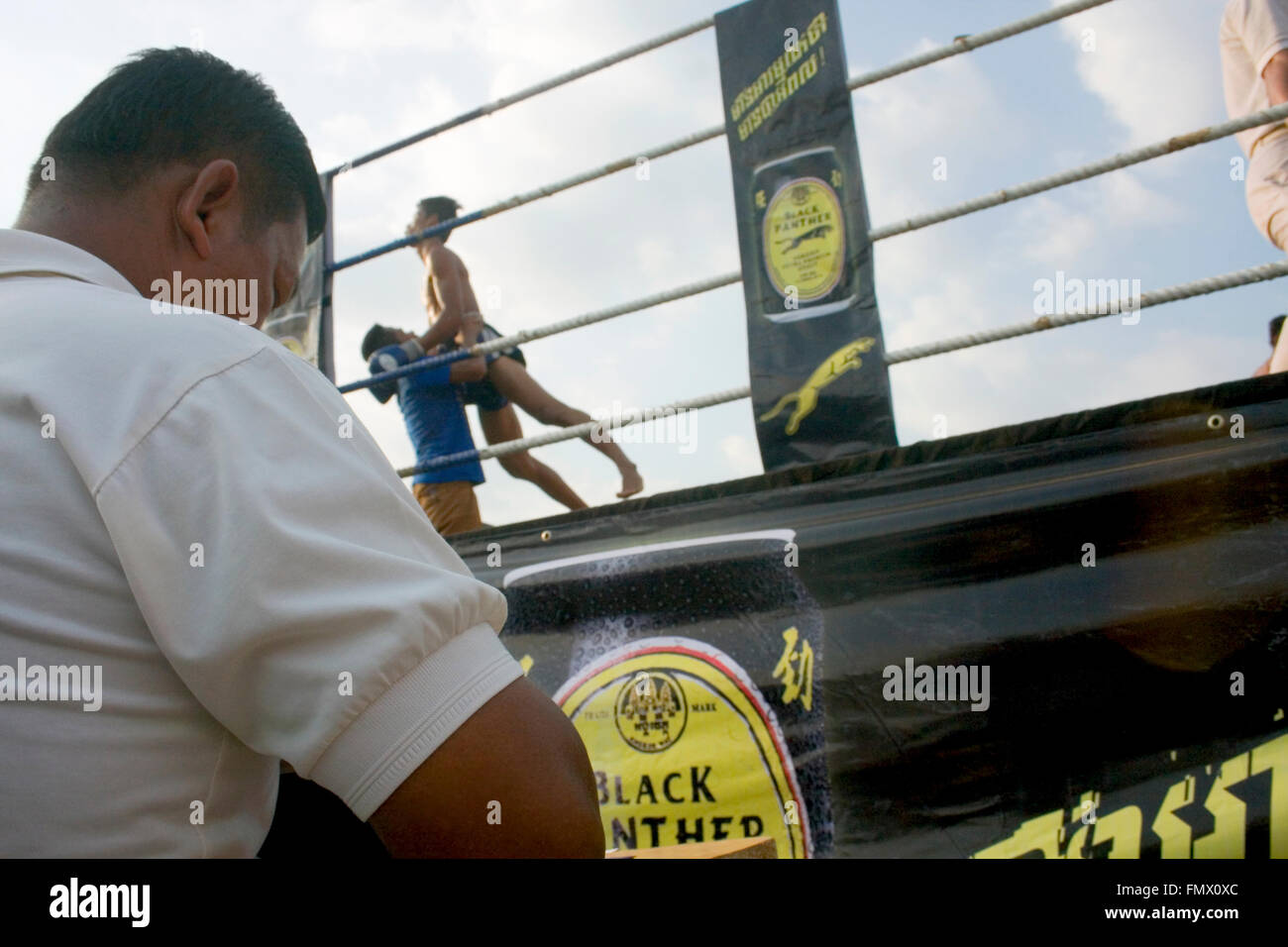 A Muay Thai boxing judge marks his card at a boxing ring at a festival ...