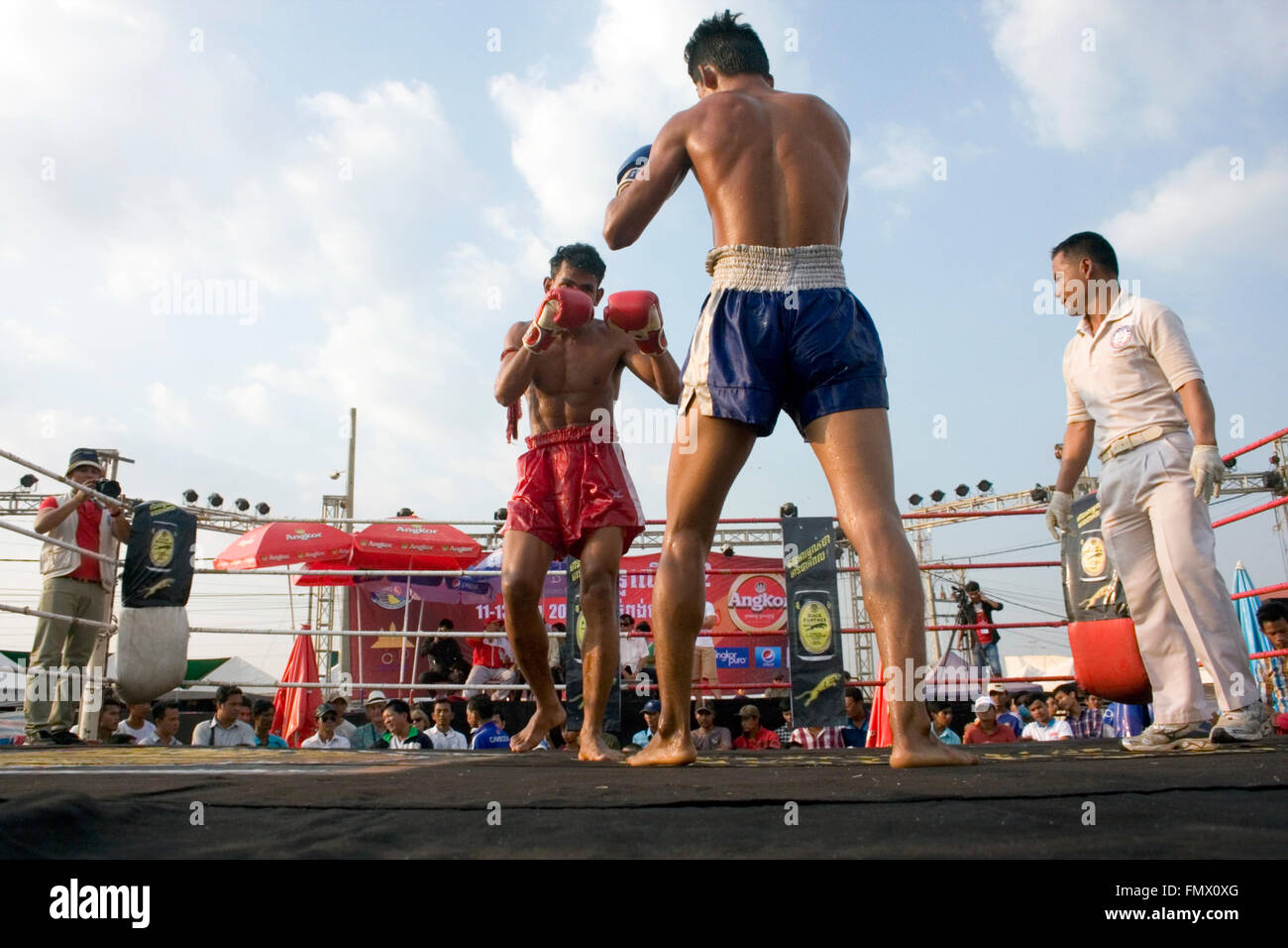 Two Muay Thai boxers are boxing in a boxing ring at a festival Kampong ...