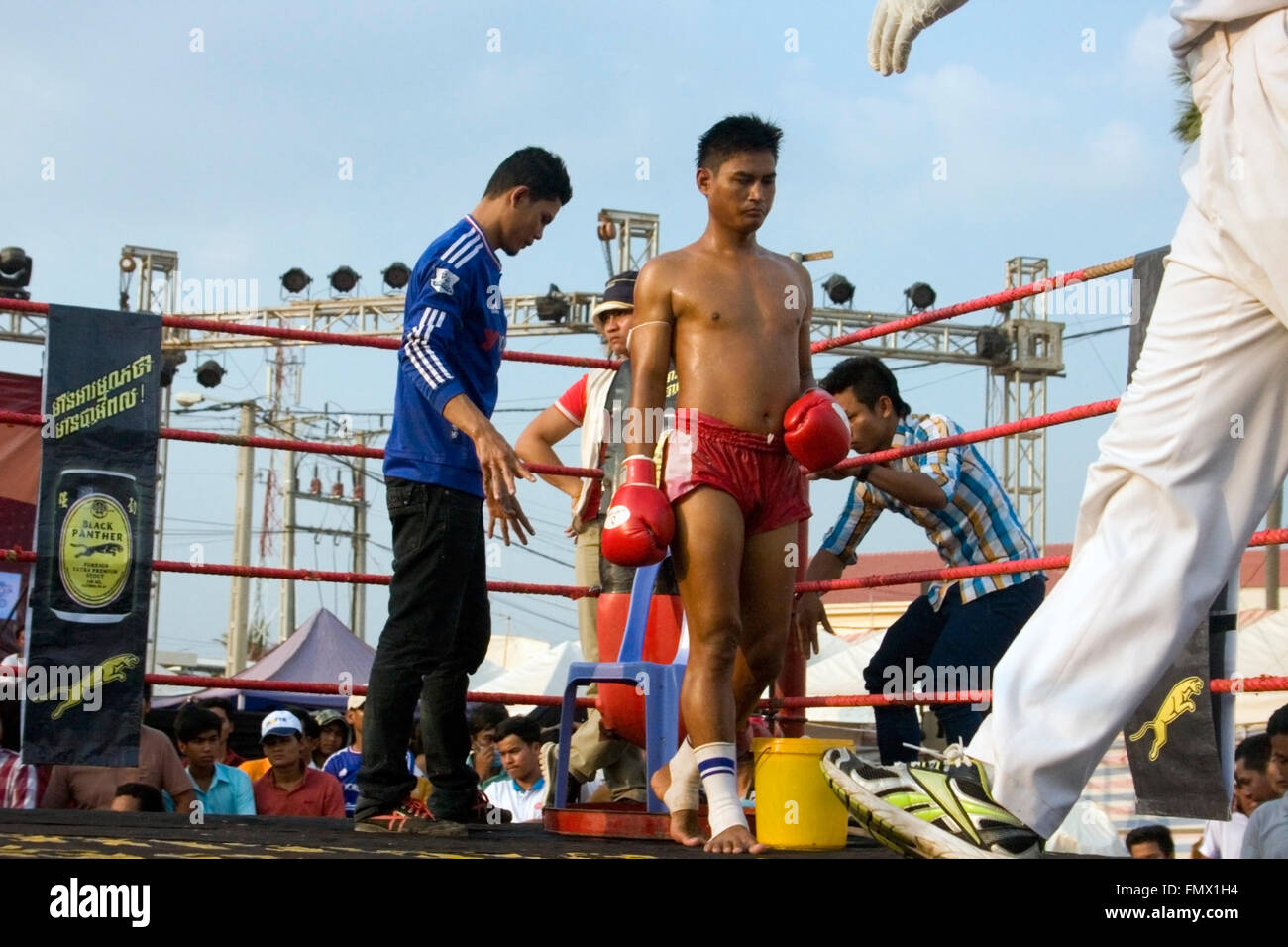 A Muay Thai boxer leaves his corner after being attended to between ...