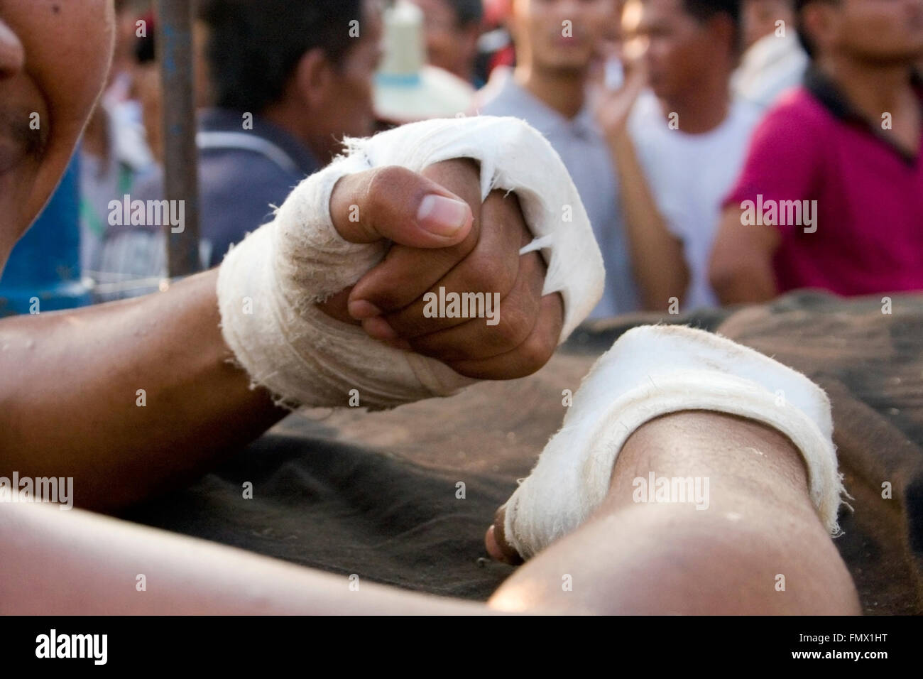 A Muay Thai boxer's taped hands are shown before he enters a boxing ...