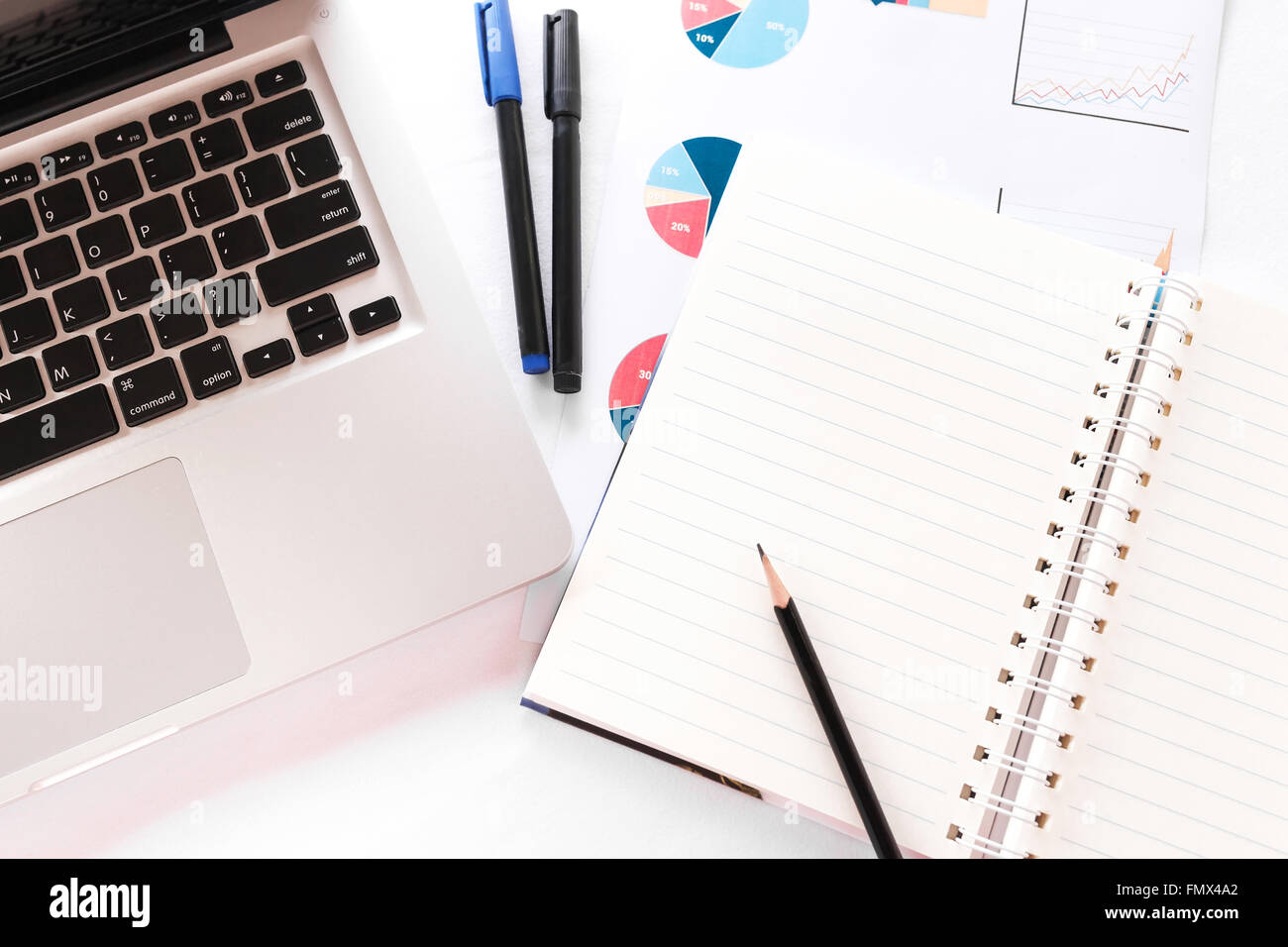 Blank note book with pencil pen and laptop on white table concept and ...