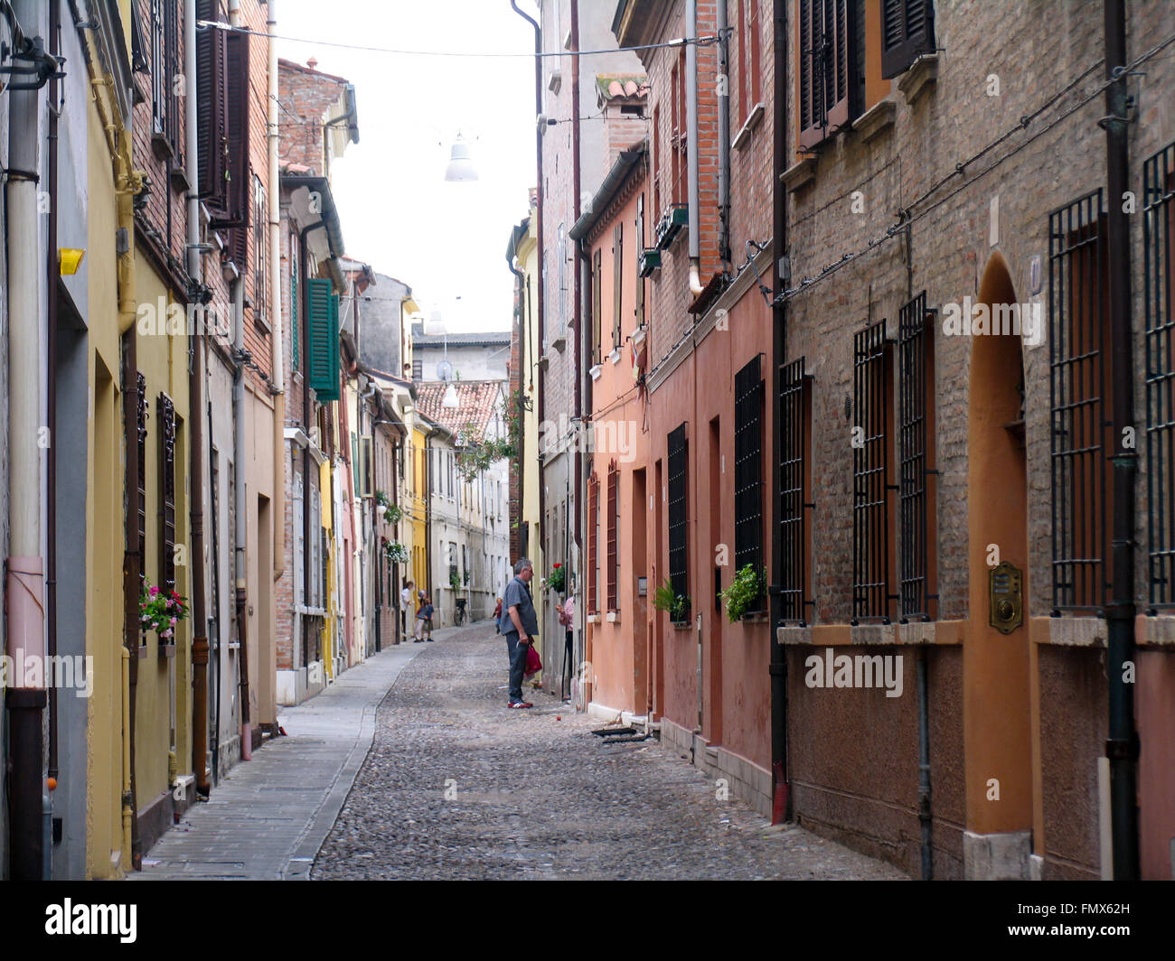 A couple standing in a doorway in a narrow laneway Stock Photo - Alamy