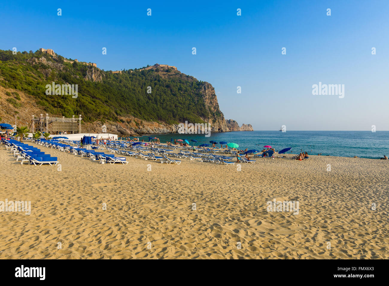 The famous sandy beach of Cleopatra at sunset. In the background, on a ...