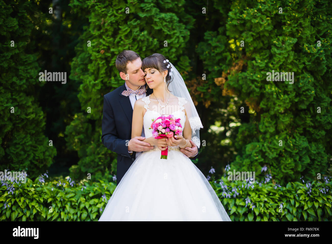 Groom hugs bride Stock Photo - Alamy