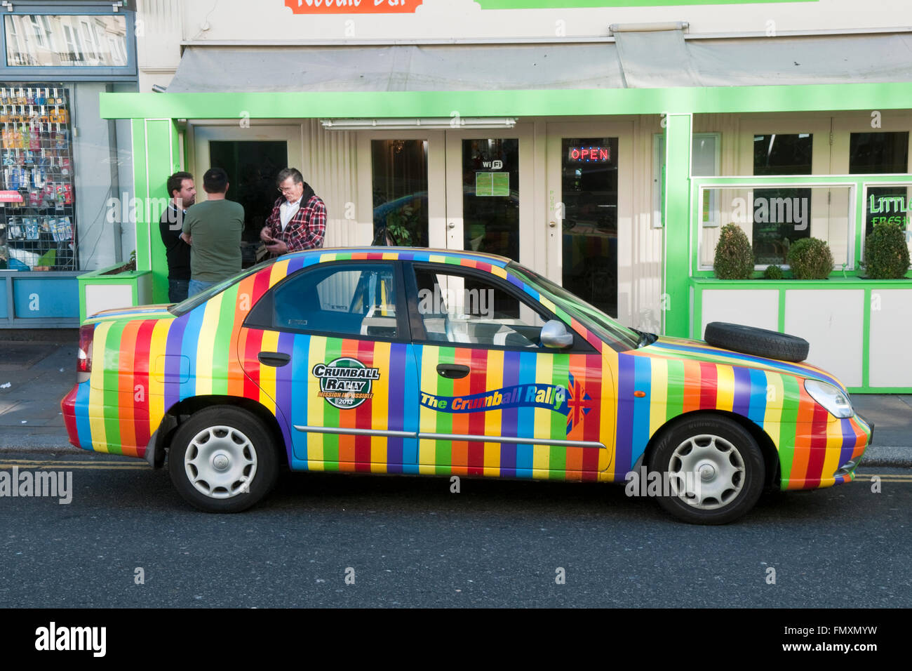 A car painted with bright rainbow stripes and featuring a Crumball ...