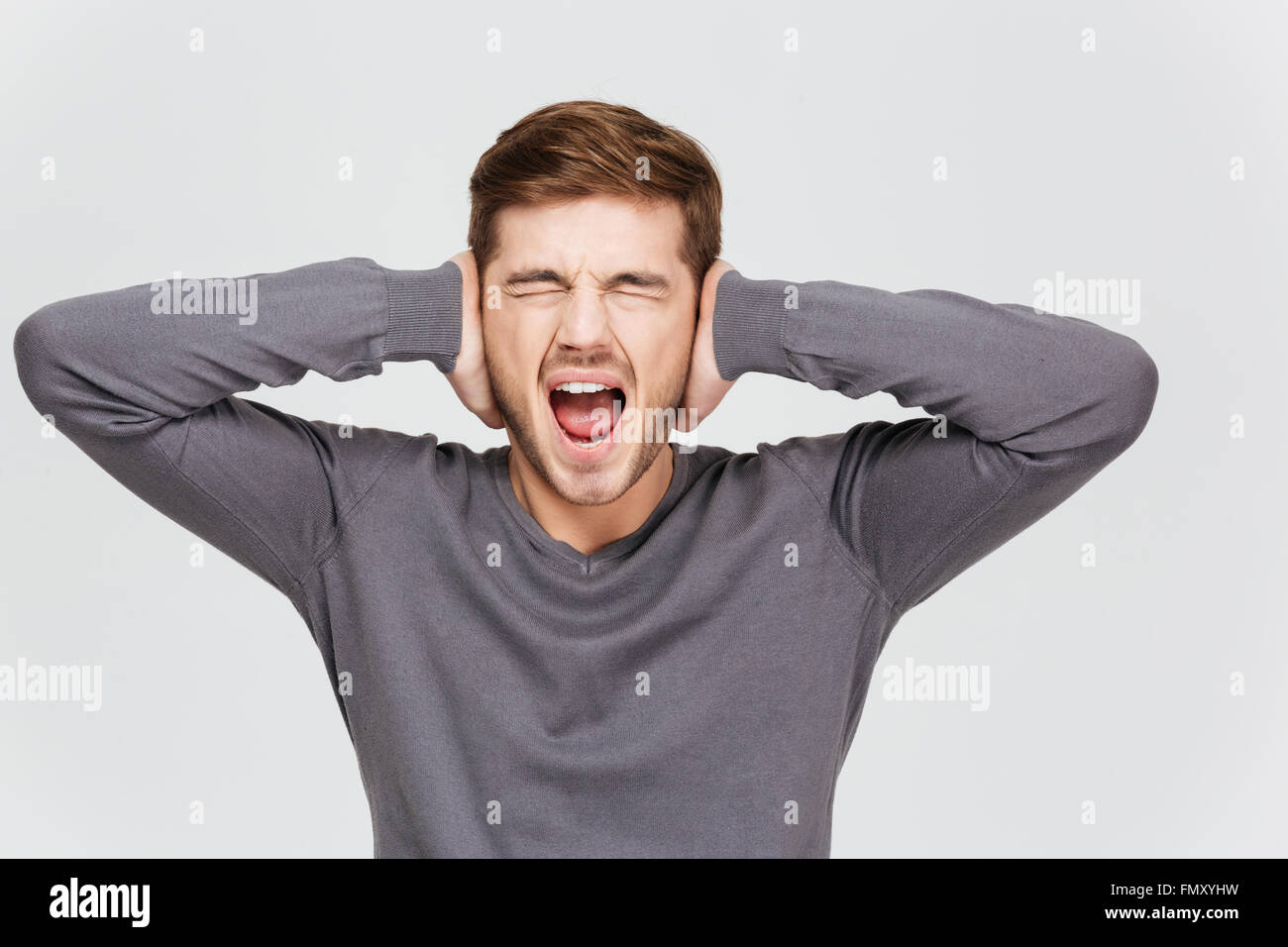 Screaming man hands in ears hi-res stock photography and images - Alamy