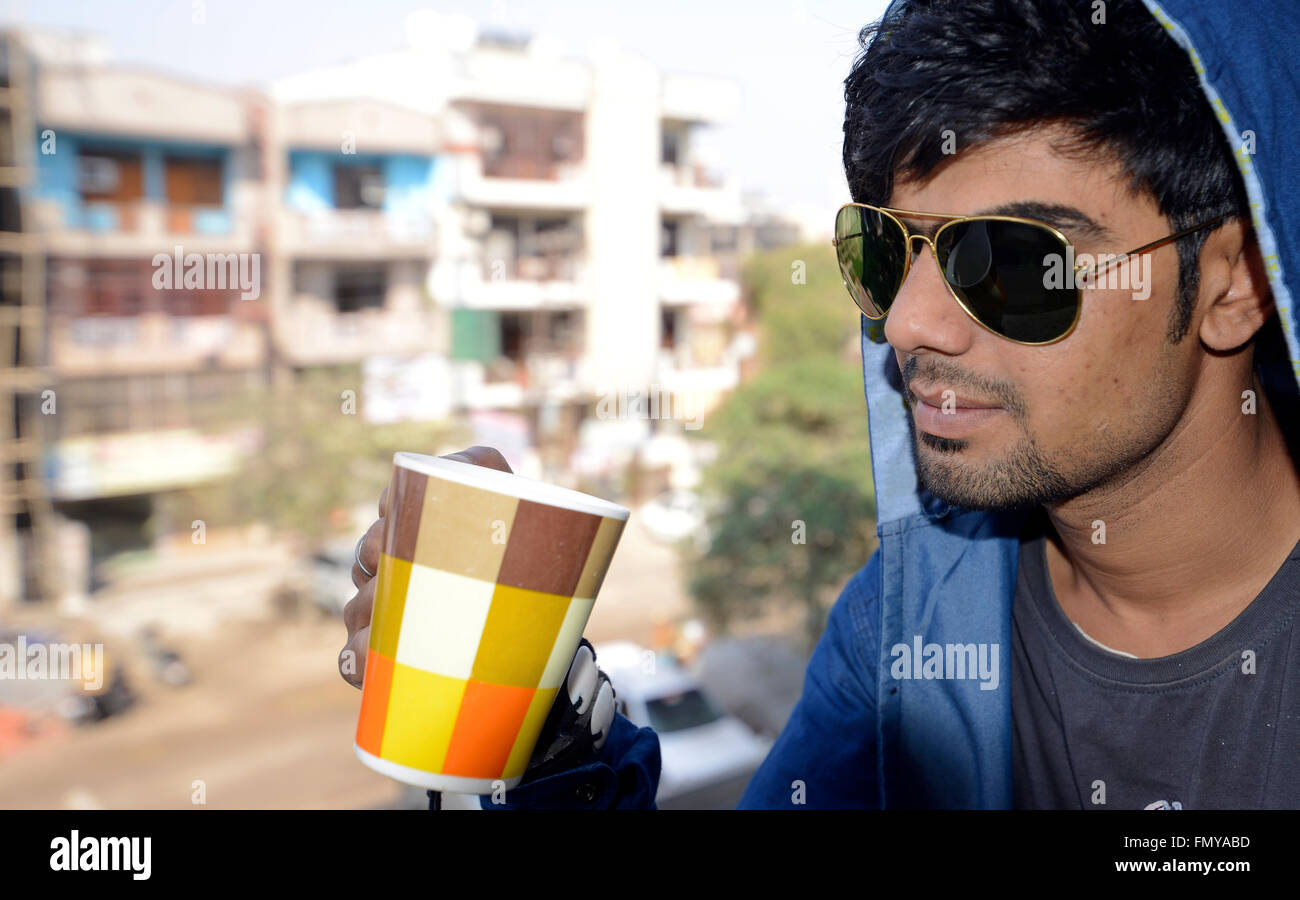Handsome guy drinking tea on Balcony Stock Photo - Alamy