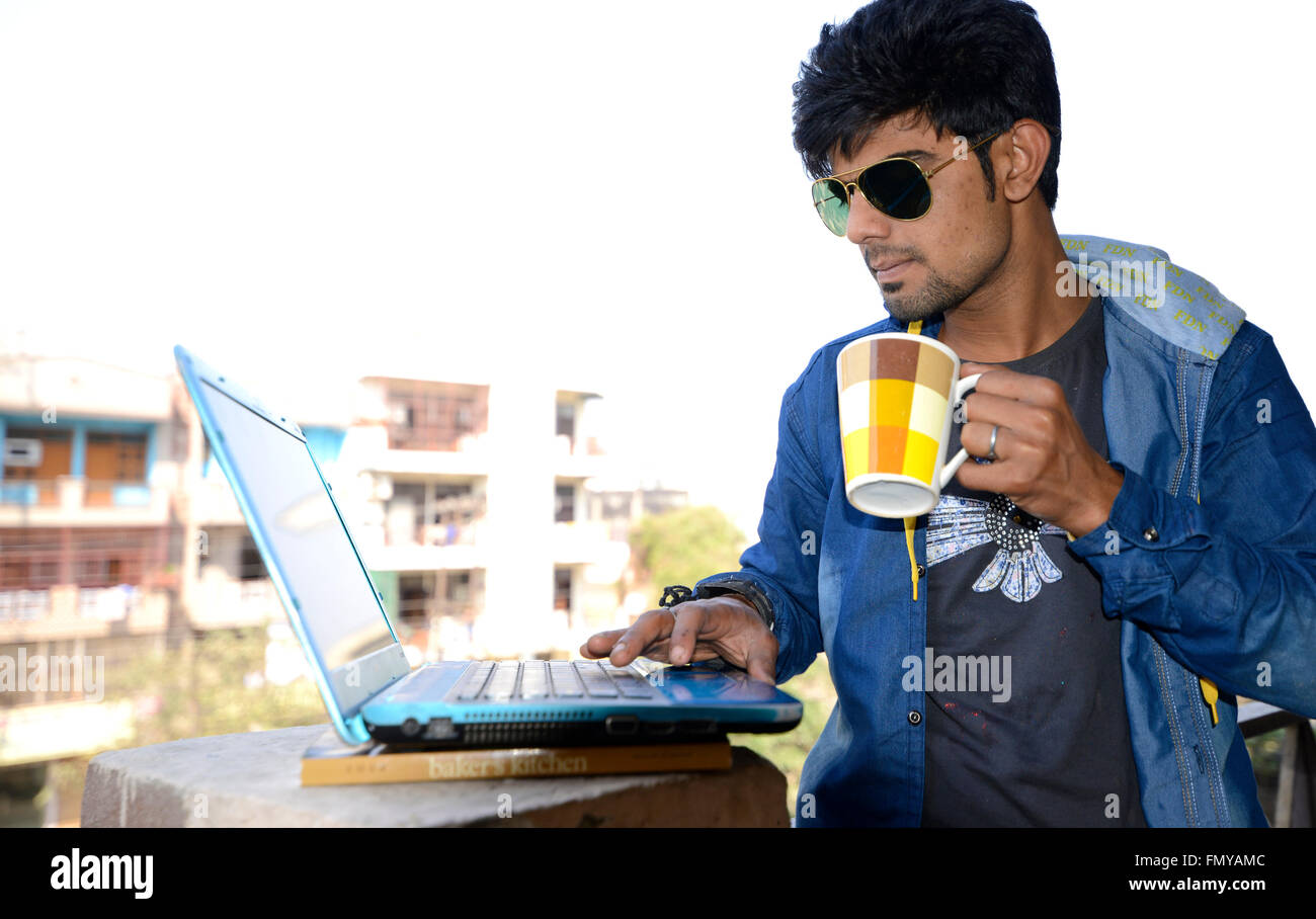 Indian young man using laptop Stock Photo - Alamy