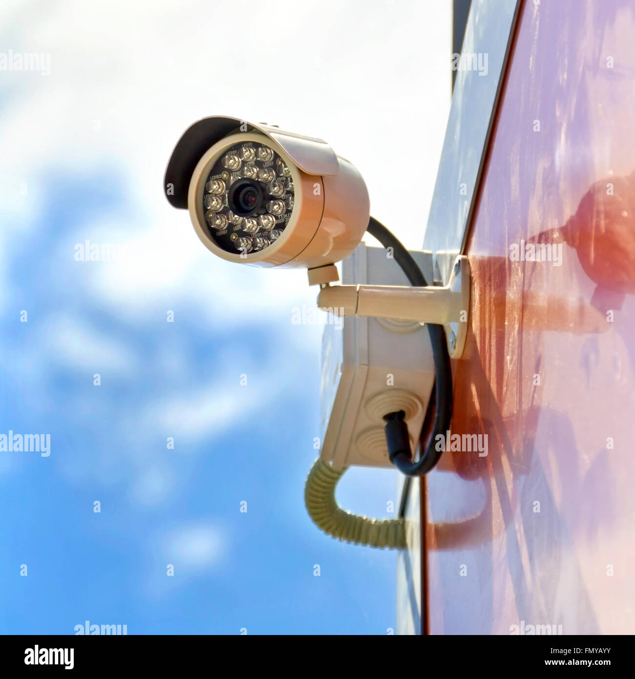 video surveillance camera on a wall of the building Stock Photo - Alamy