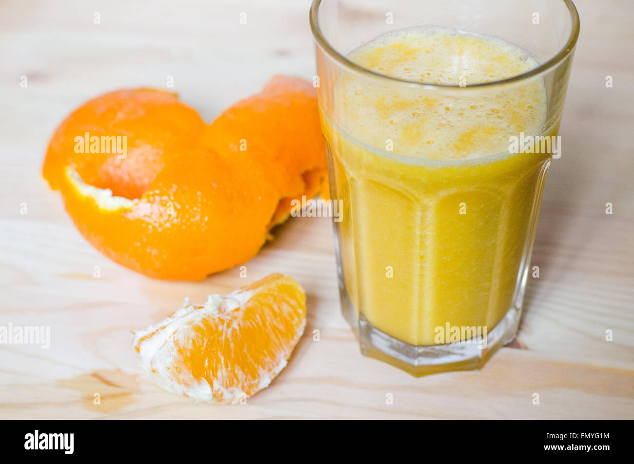 fresh mixed orange juice on the wooden table Stock Photo - Alamy