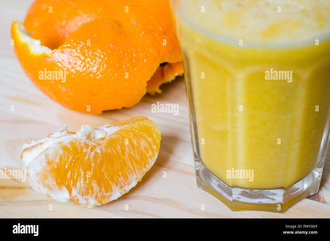 fresh mixed orange juice on the wooden table Stock Photo - Alamy