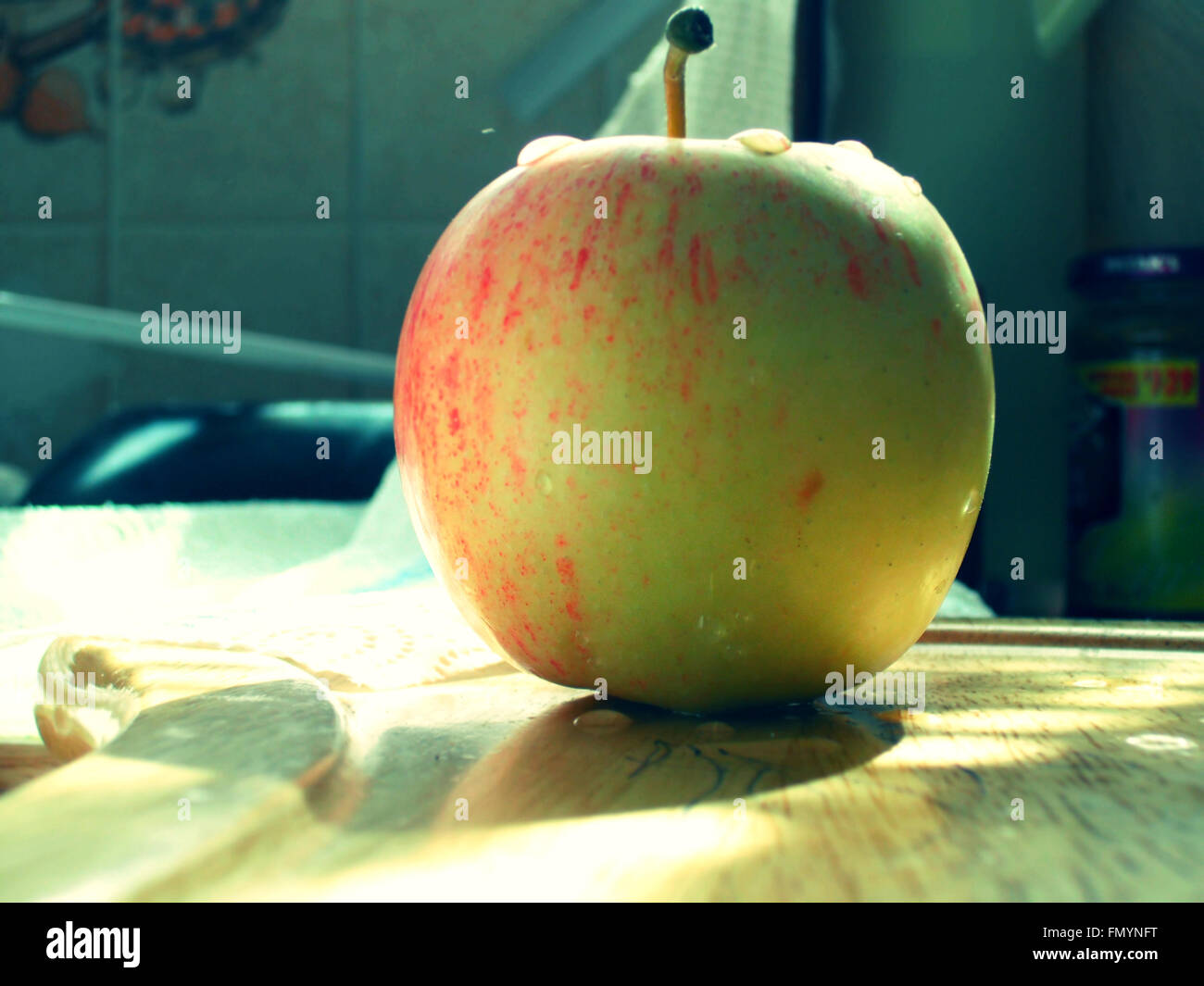 An Apple with beautiful water drops and a natural light Stock Photo - Alamy