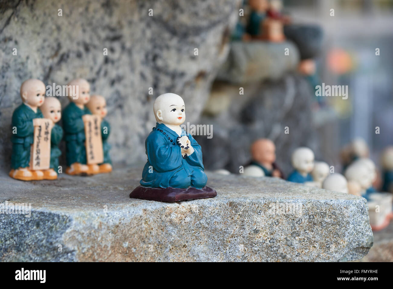 closeup of small praying monk figure on a rock Stock Photo - Alamy
