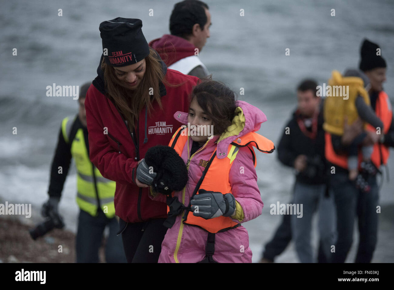 Lesvos, Greece. 13th Mar, 2016. Volunteers and rescuers take care of ...
