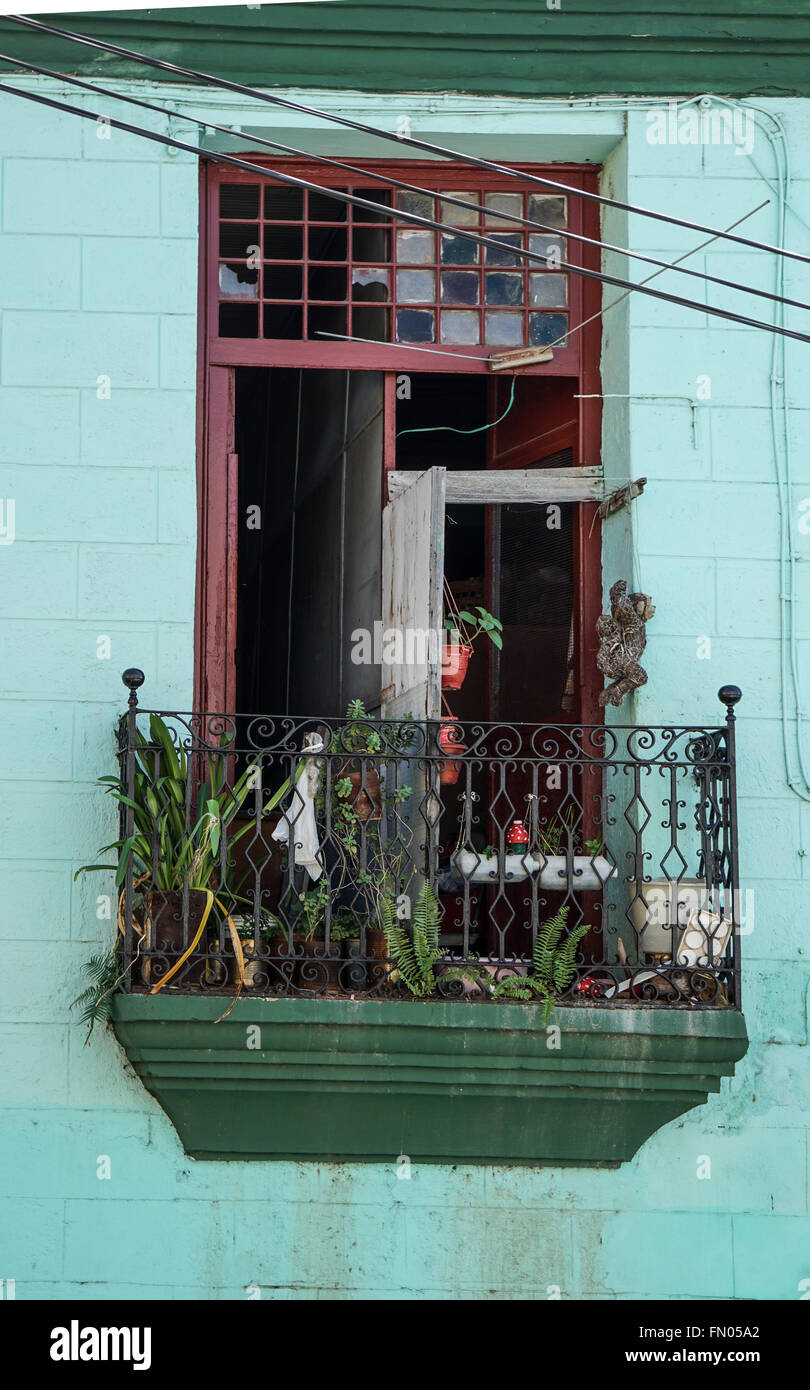 house wall with window with stained glass windows and missing glass and ...