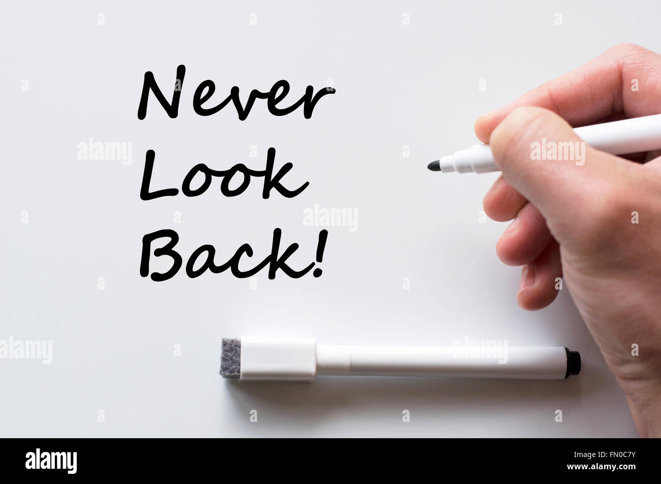 Human hand writing never look back on whiteboard Stock Photo - Alamy