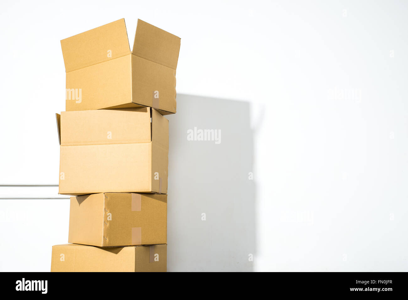 Pile of cardboard boxes on white background with box shadow, nobody ...