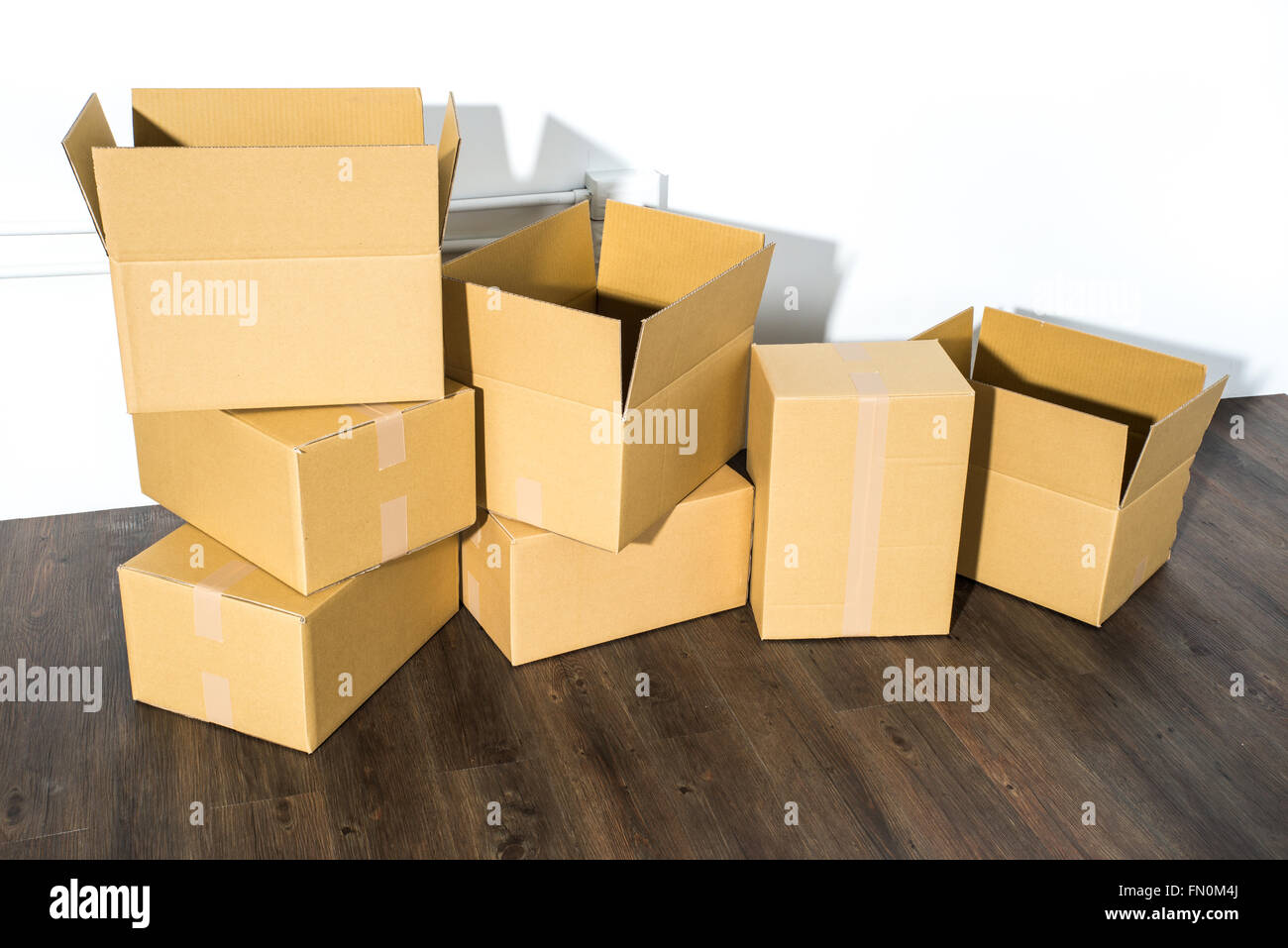 Pile of cardboard boxes on white background with box shadow, nobody ...