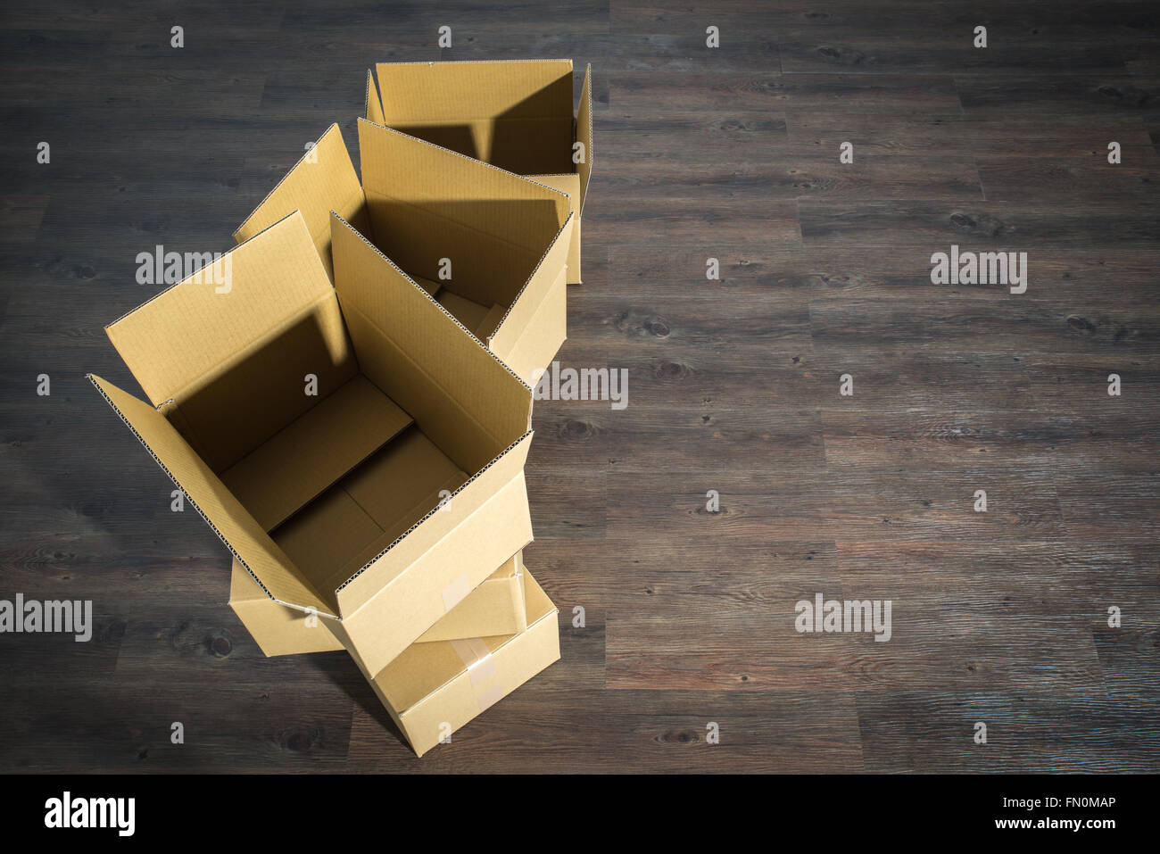 Pile of cardboard boxes on parquet home relocation, nobody Stock Photo ...