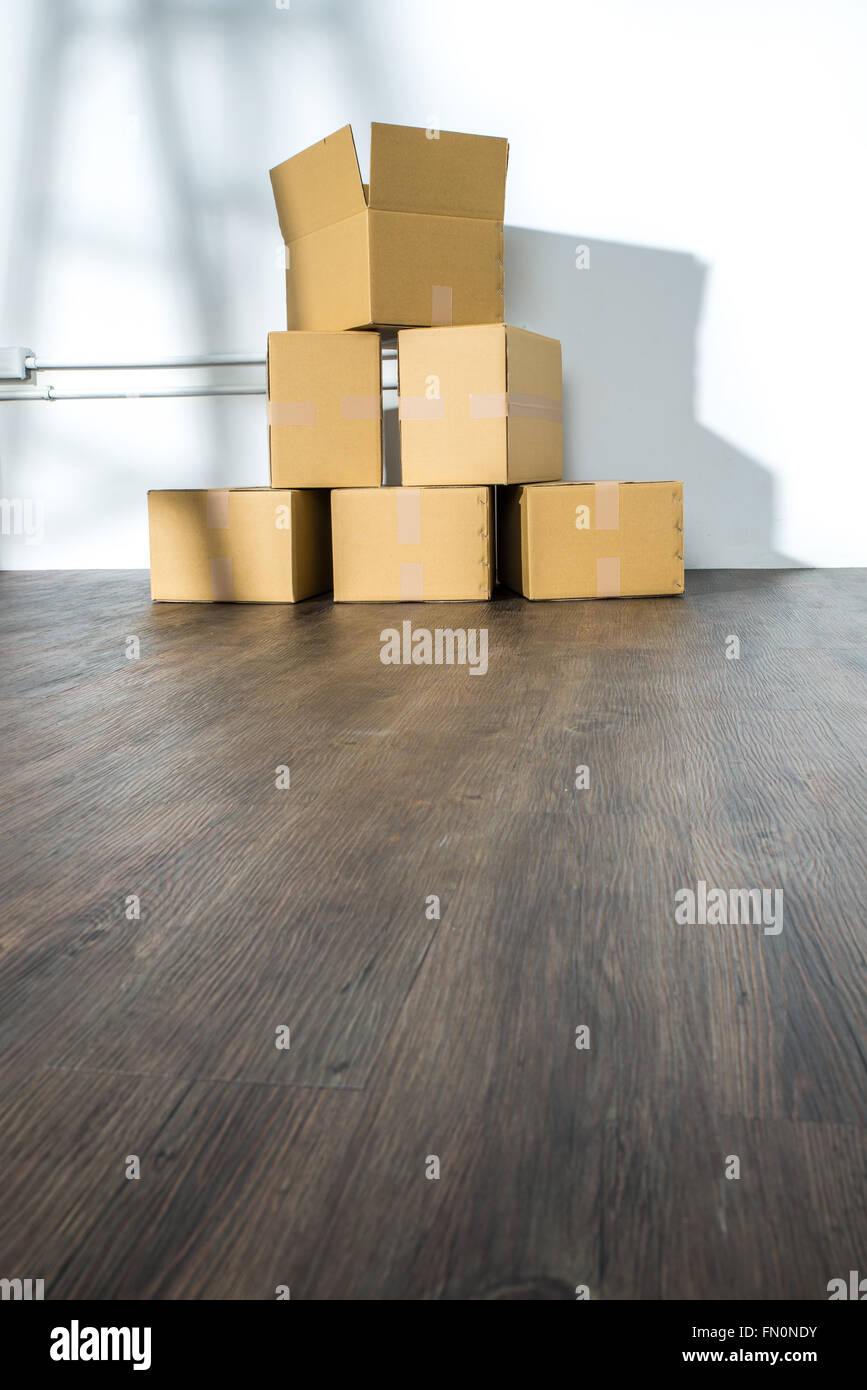 Pile of cardboard boxes on white background with Ladder shadow, nobody ...