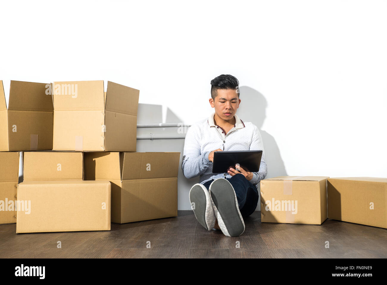 Sitting man sitting on boxes hi-res stock photography and images - Alamy