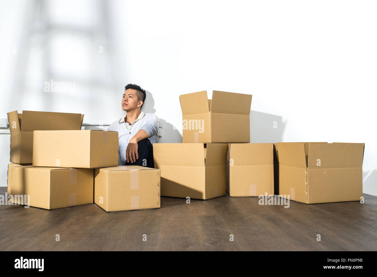 Sitting man sitting on boxes hi-res stock photography and images - Alamy