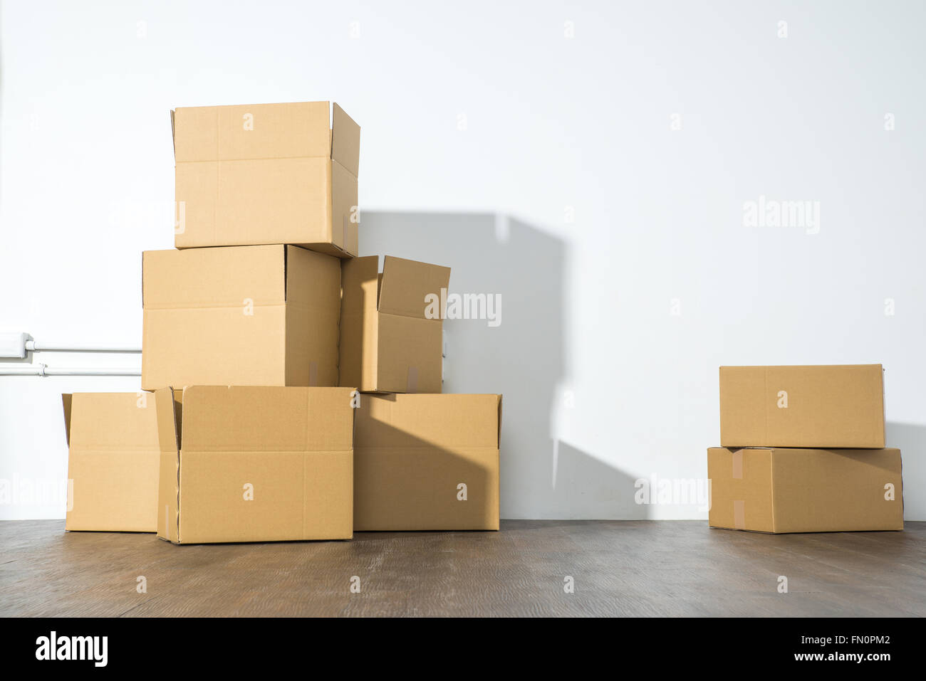 Pile of cardboard boxes on white background with box shadow, nobody ...