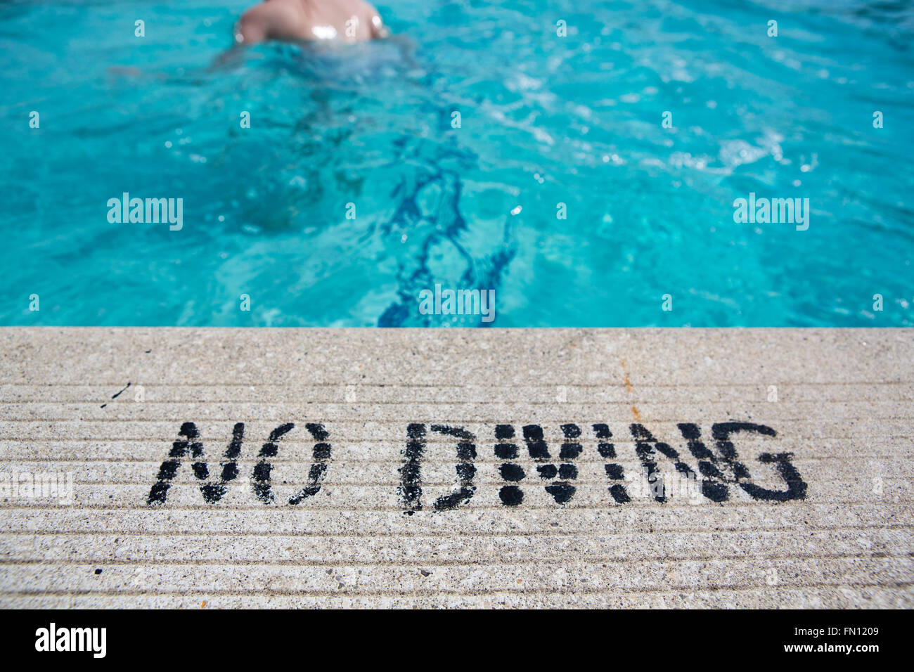 A samll outdoor pool with typed message on the stone side Stock Photo ...