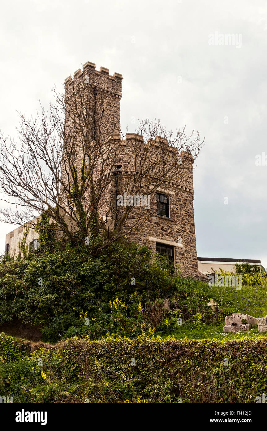 The stark stone tower and turret of the small limestone and slate ...