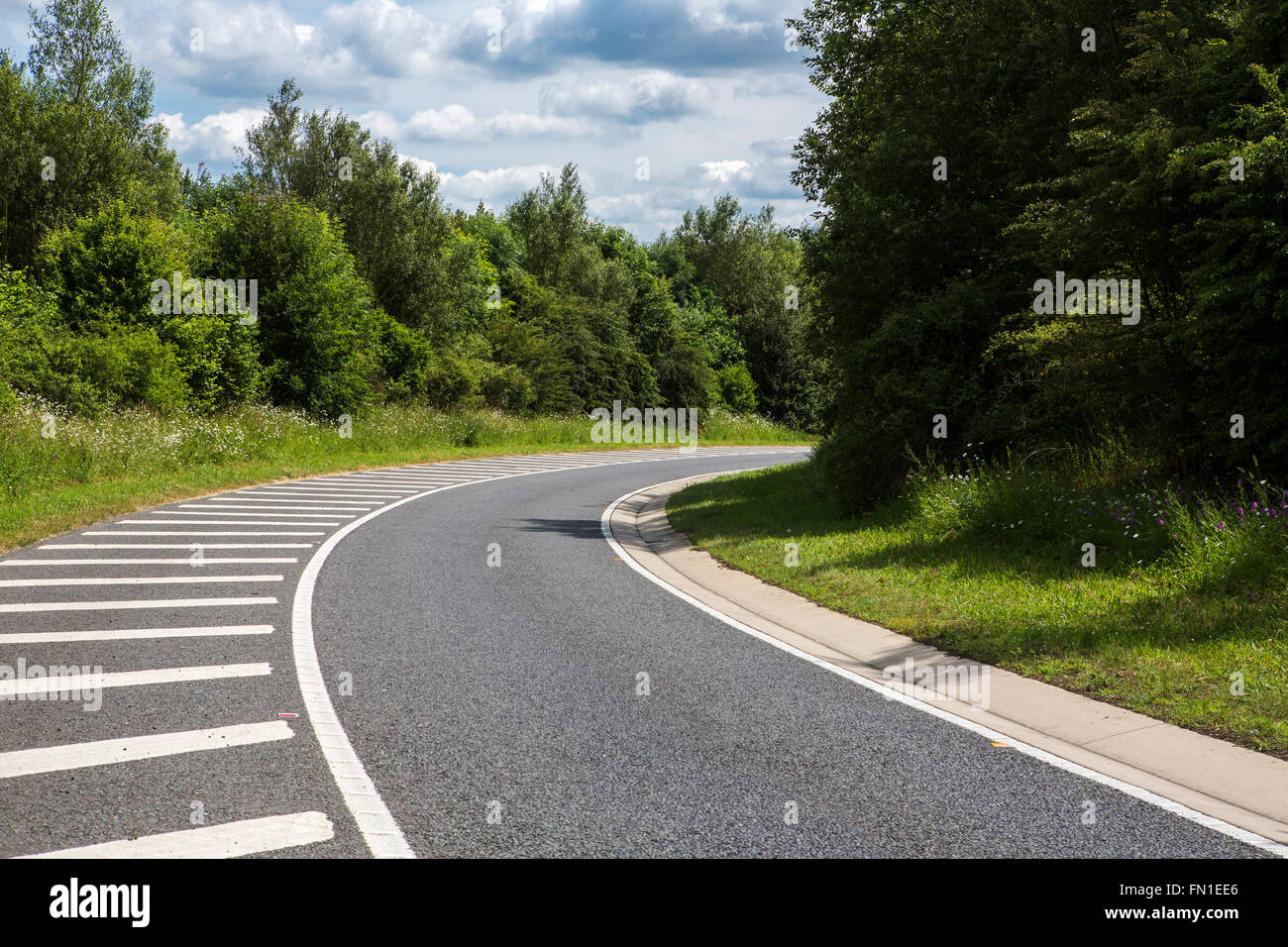 A slip road curving round at the entrance to a dual carrigeway Stock ...