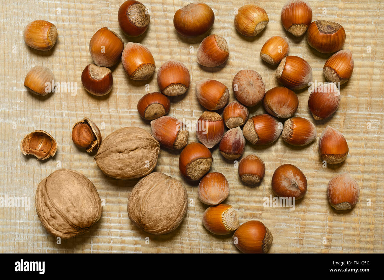 Nuts scattered on the old boards Stock Photo - Alamy