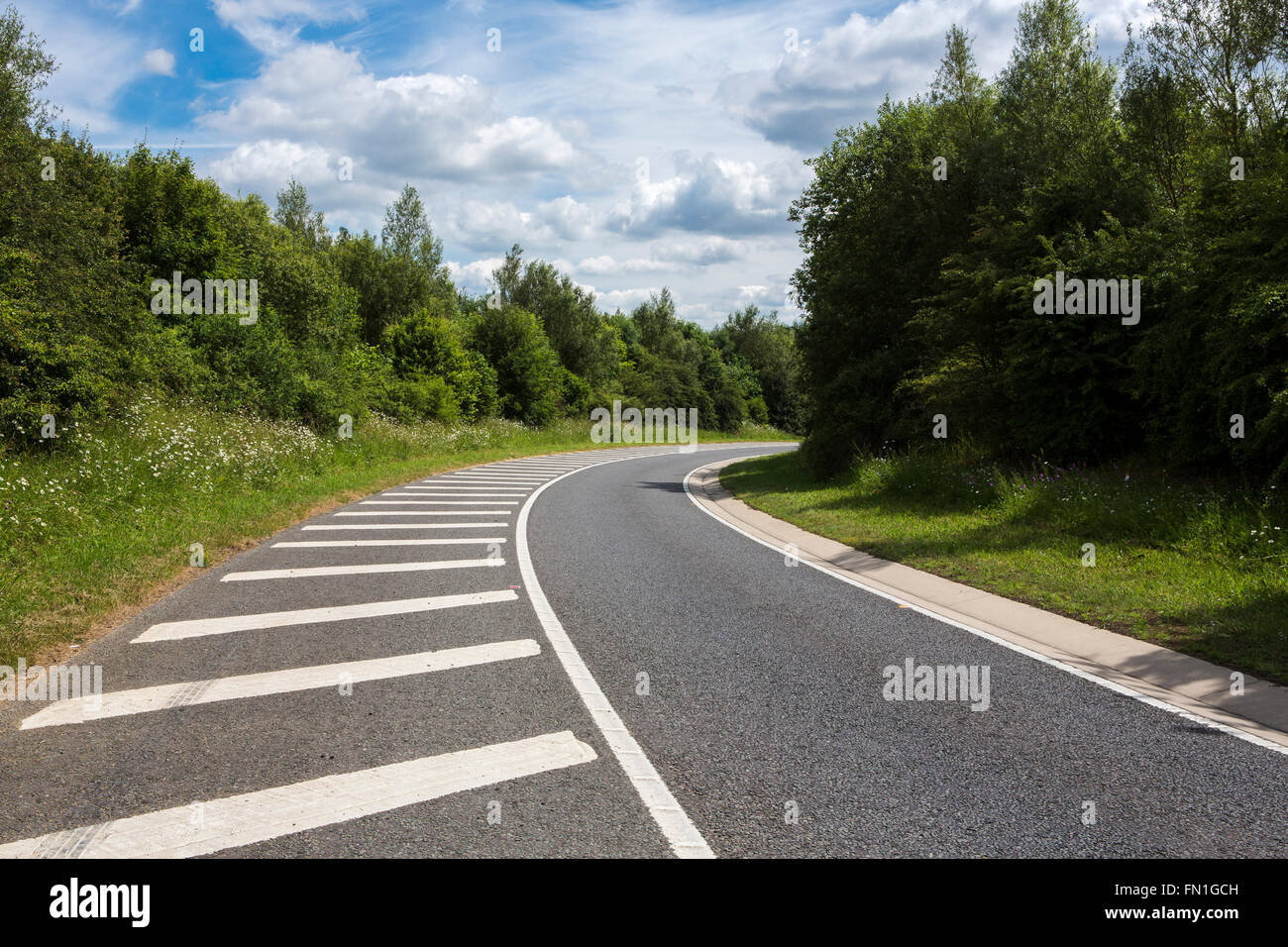 A slip road curving round at the entrance to a dual carrigeway Stock ...