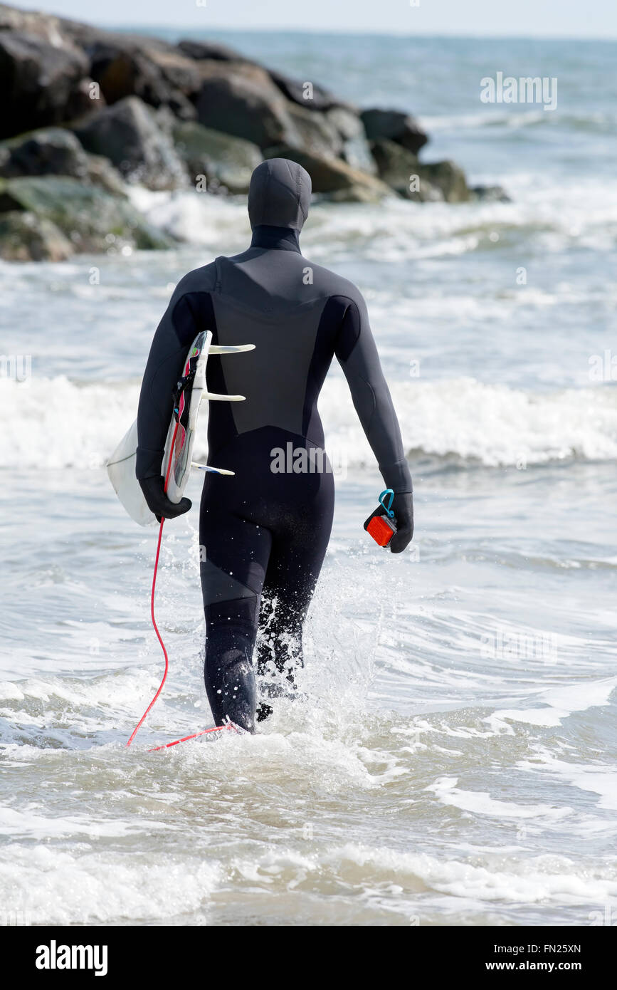 Surfer Heads Out to Catch More Waves Stock Photo - Alamy