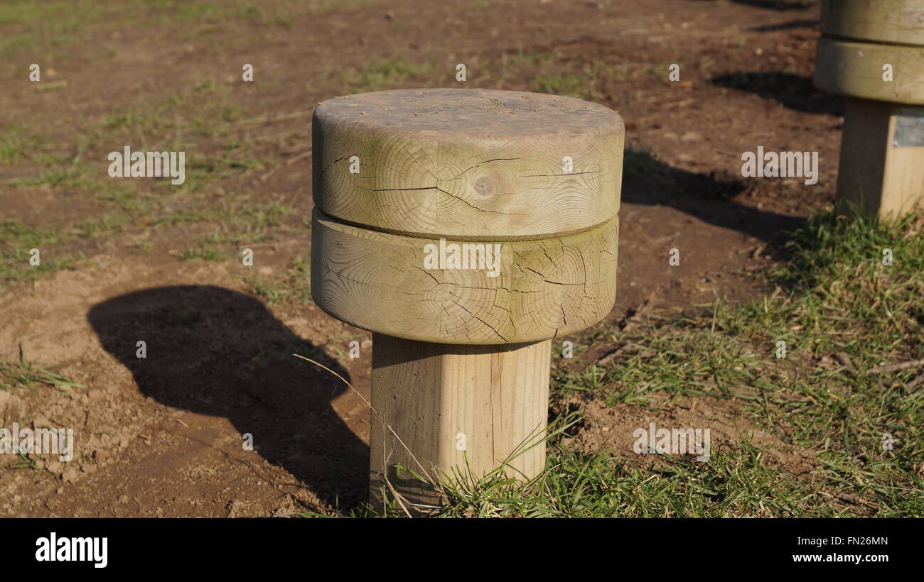 Wooden sitting post in sunshine Stock Photo - Alamy